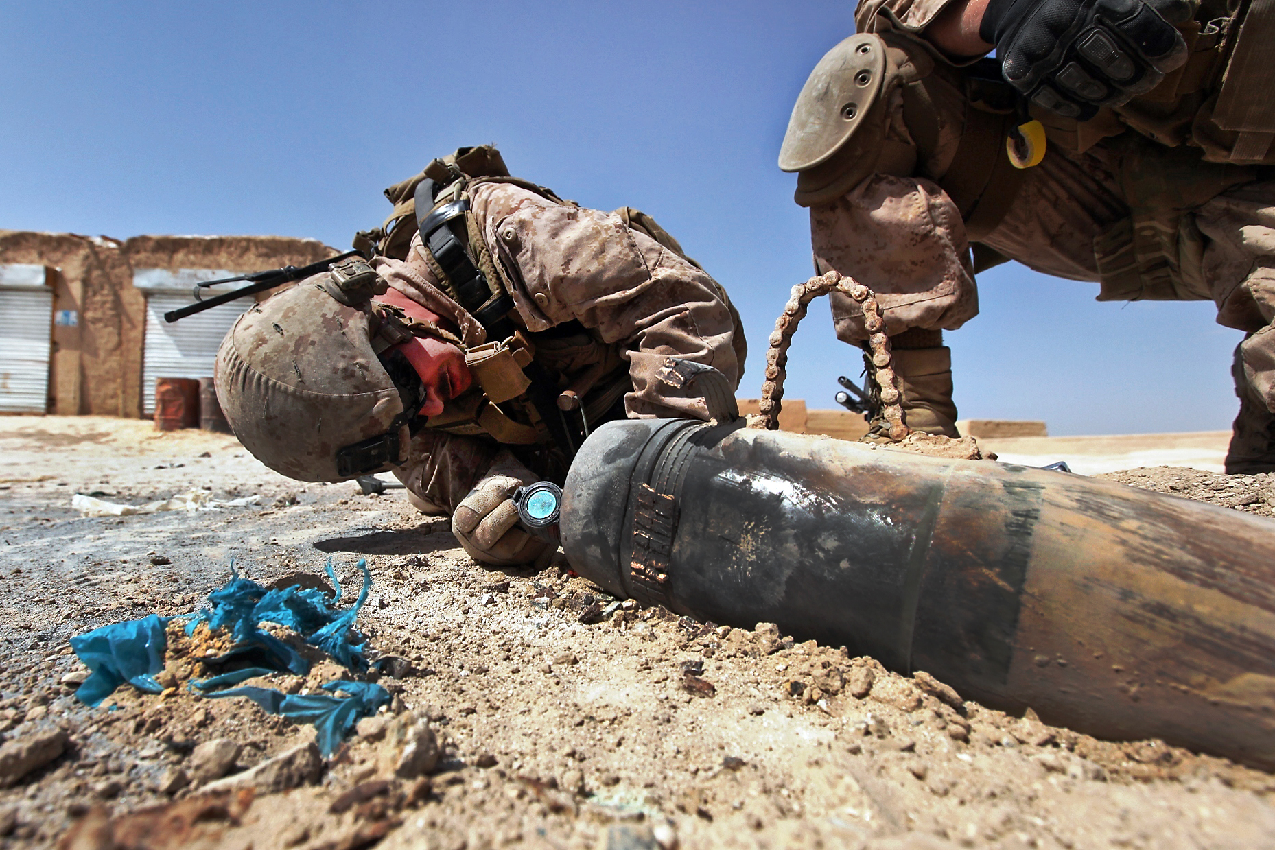 U.S. Marine Corps Staff Sgt. Brandon Trent inspects an improvised ...