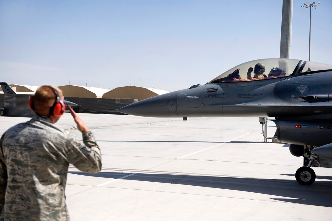 U.S. Air Force Staff Sgt. Jared Newman salutes U.S. Air Force Brig. Gen ...