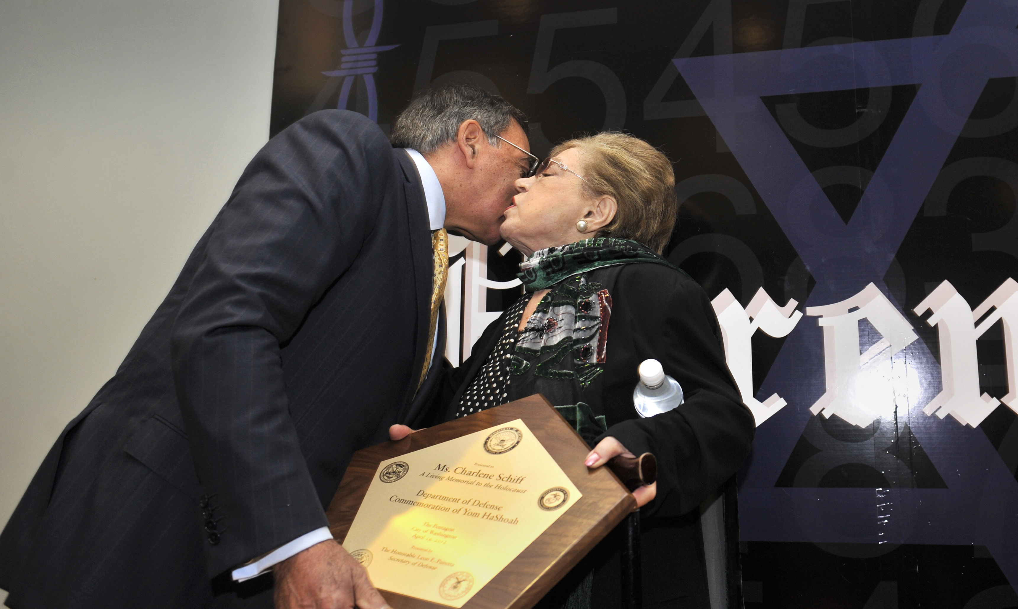 Defense Secretary Leon E. Panetta receives a kiss on the cheek as he ...