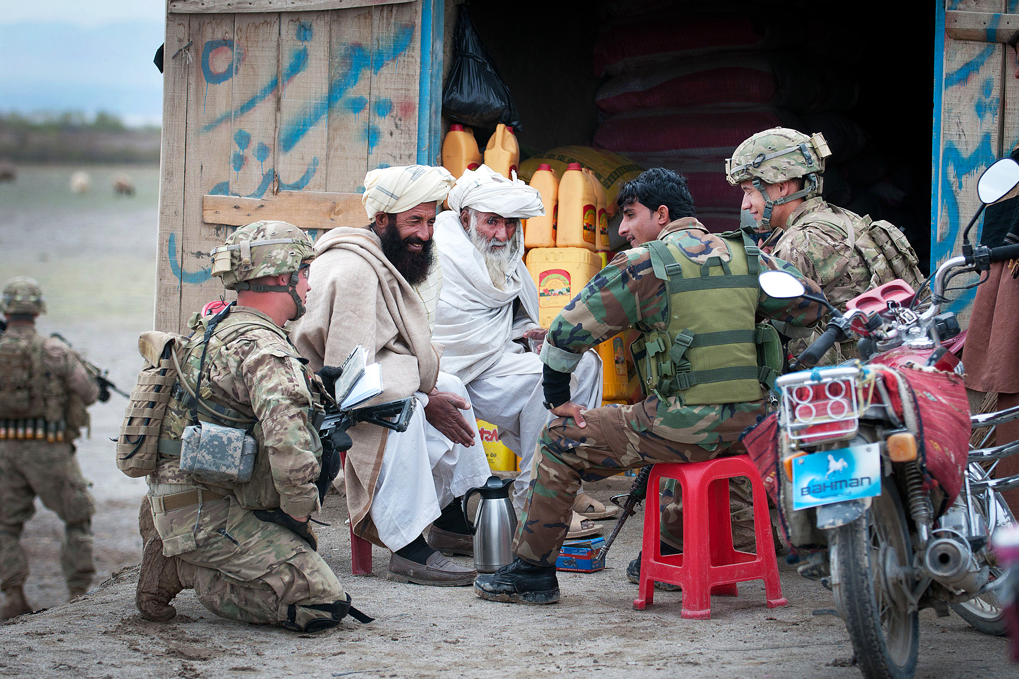 U.S. Army 2nd Lt. Anthony Pappas laughs with village elders and an ...