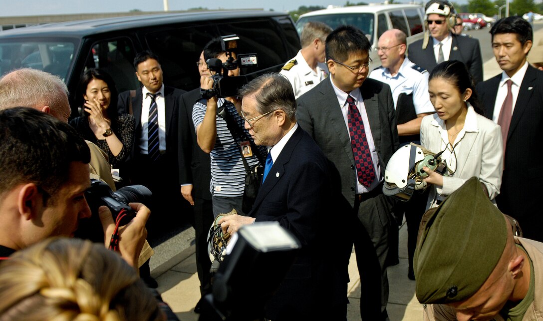 Japanese Defense Minister Satoshi Morimoto prepares to board a V-22 ...