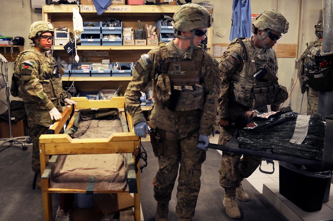 U.S. troops prepare to treat a simulated causality on Camp Nathan Smith ...