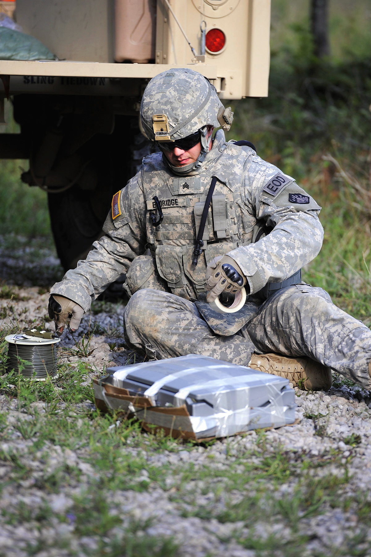 Army Sgt. Matthew Eldridge preps “boot banger,” a water disrupting charge, for a vehicle ...