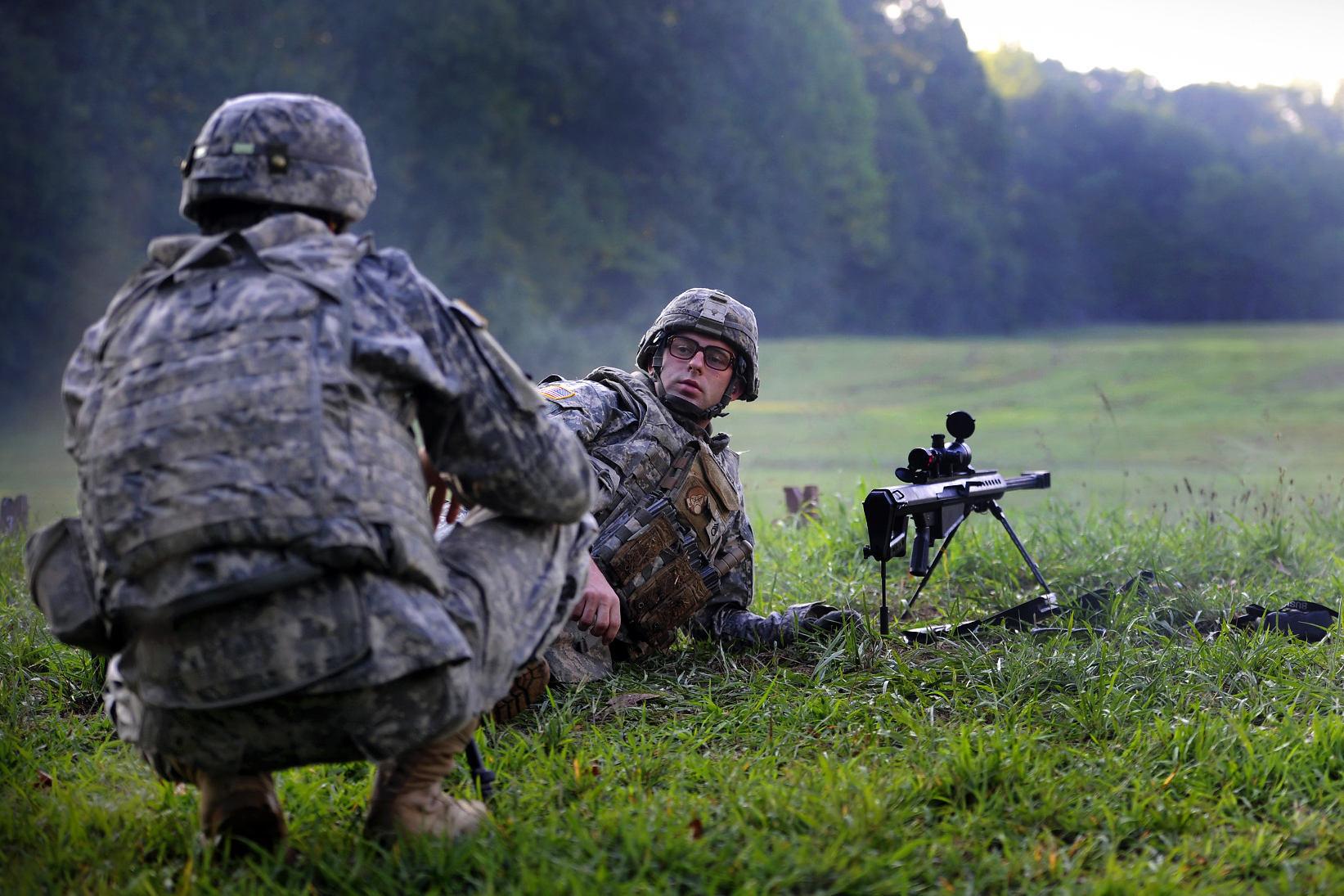 Army Staff Sgt. Christopher Thompson, front, discusses shooting ...