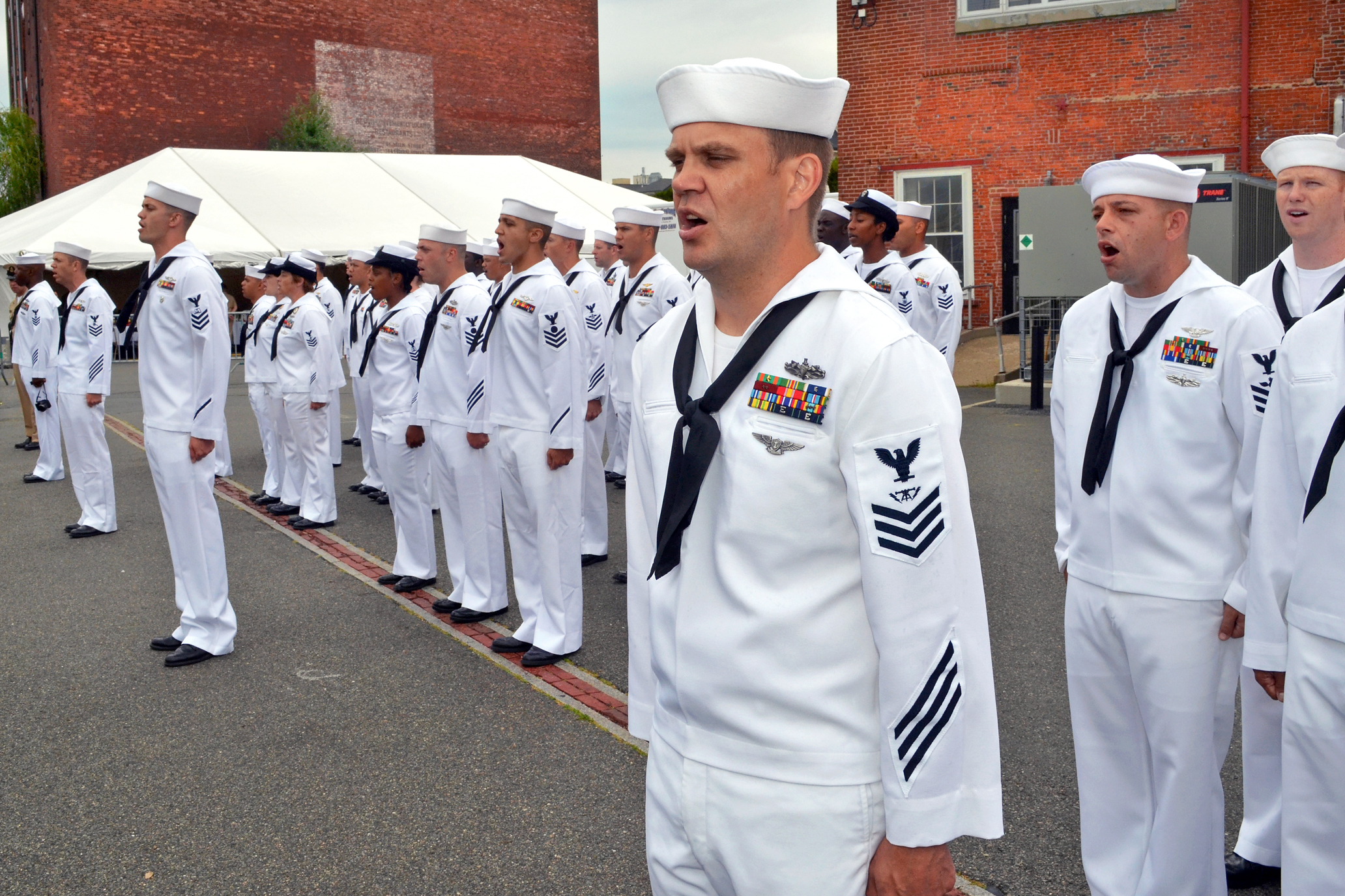 Navy chief petty officer selectees sing "Anchors Aweigh," in formation ...