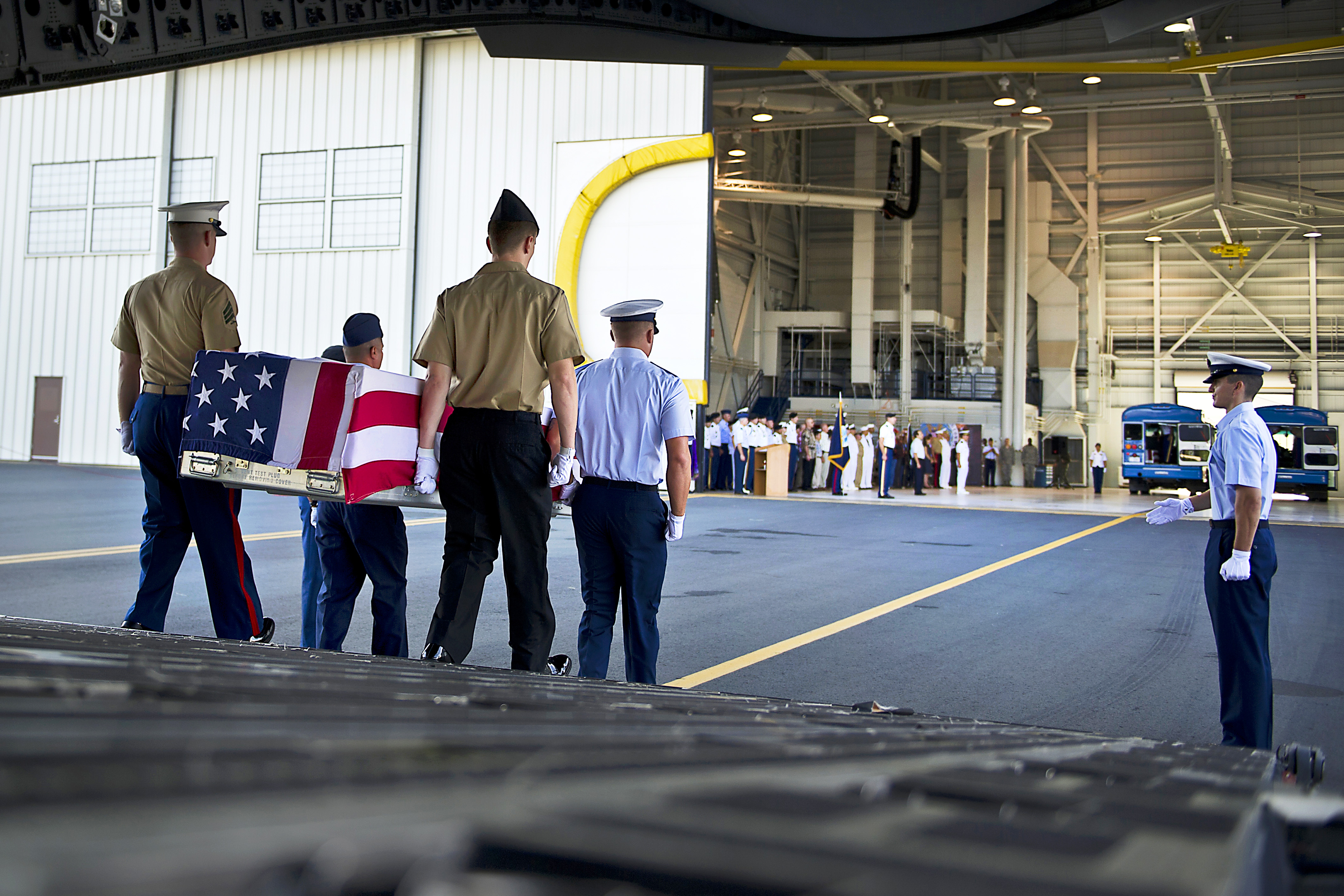An honor detail comprised of joint military members escorts a flag ...