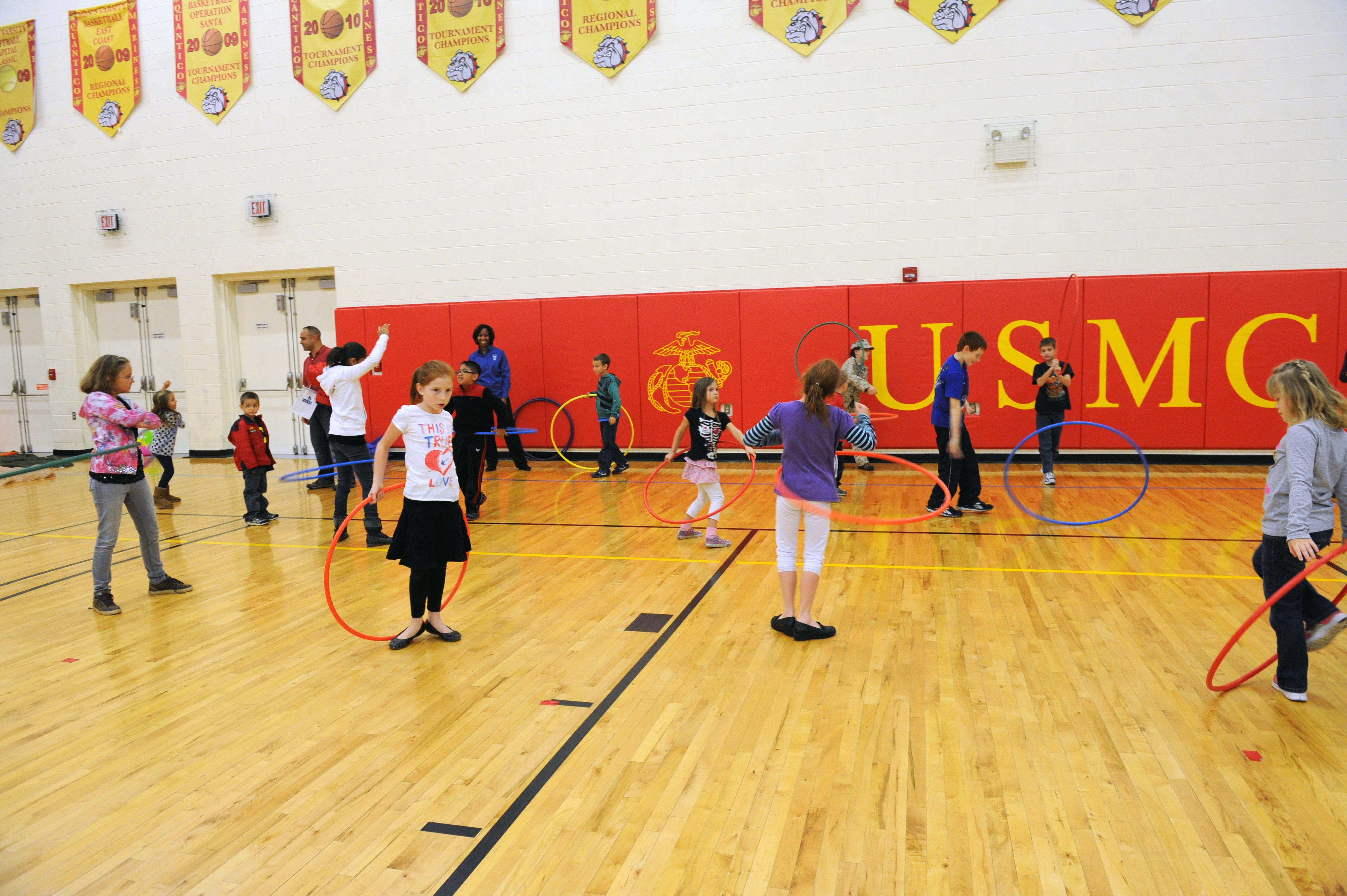 Children twirl hula hoops during the first USMC Kids’ Birthday Bash was ...