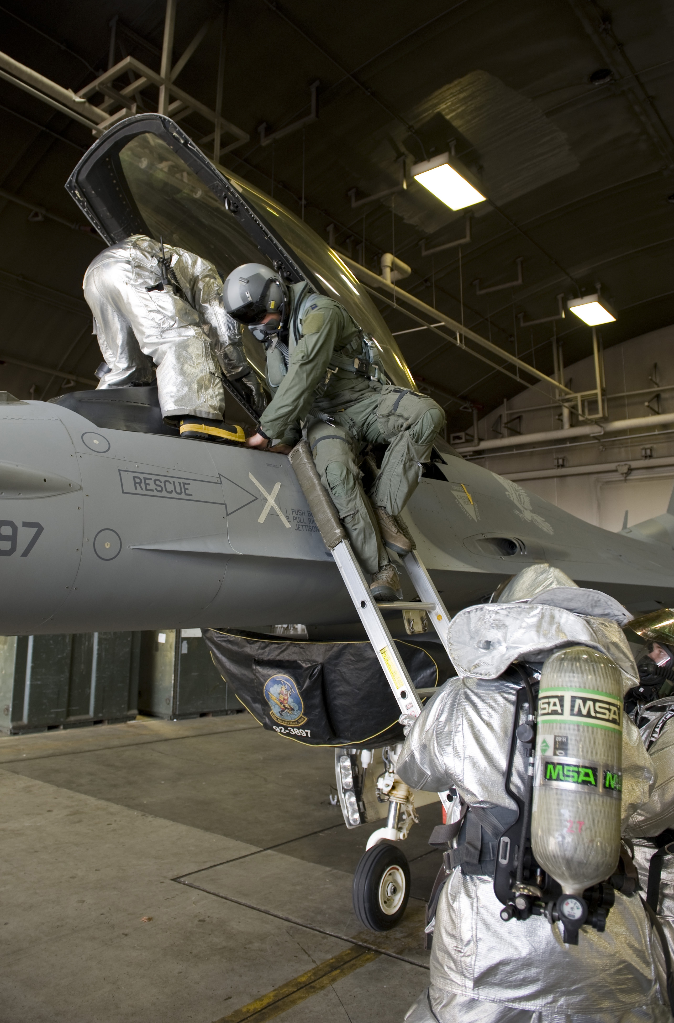 Firefighters perform pilot egress during ORE