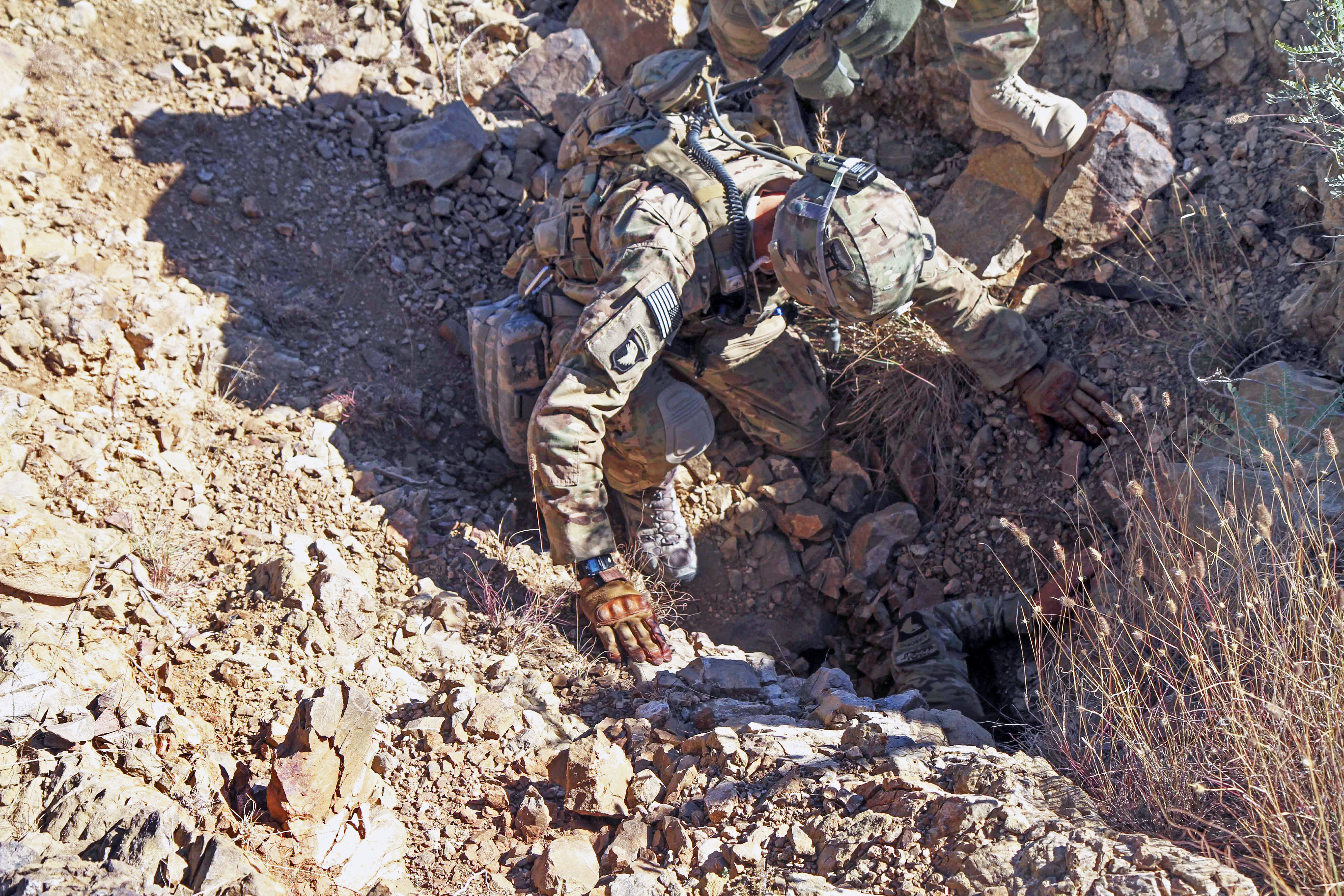 U.S. Army Sgt. Nathan Fleshman, center, helps U.S. Army Pvt. Stephen ...