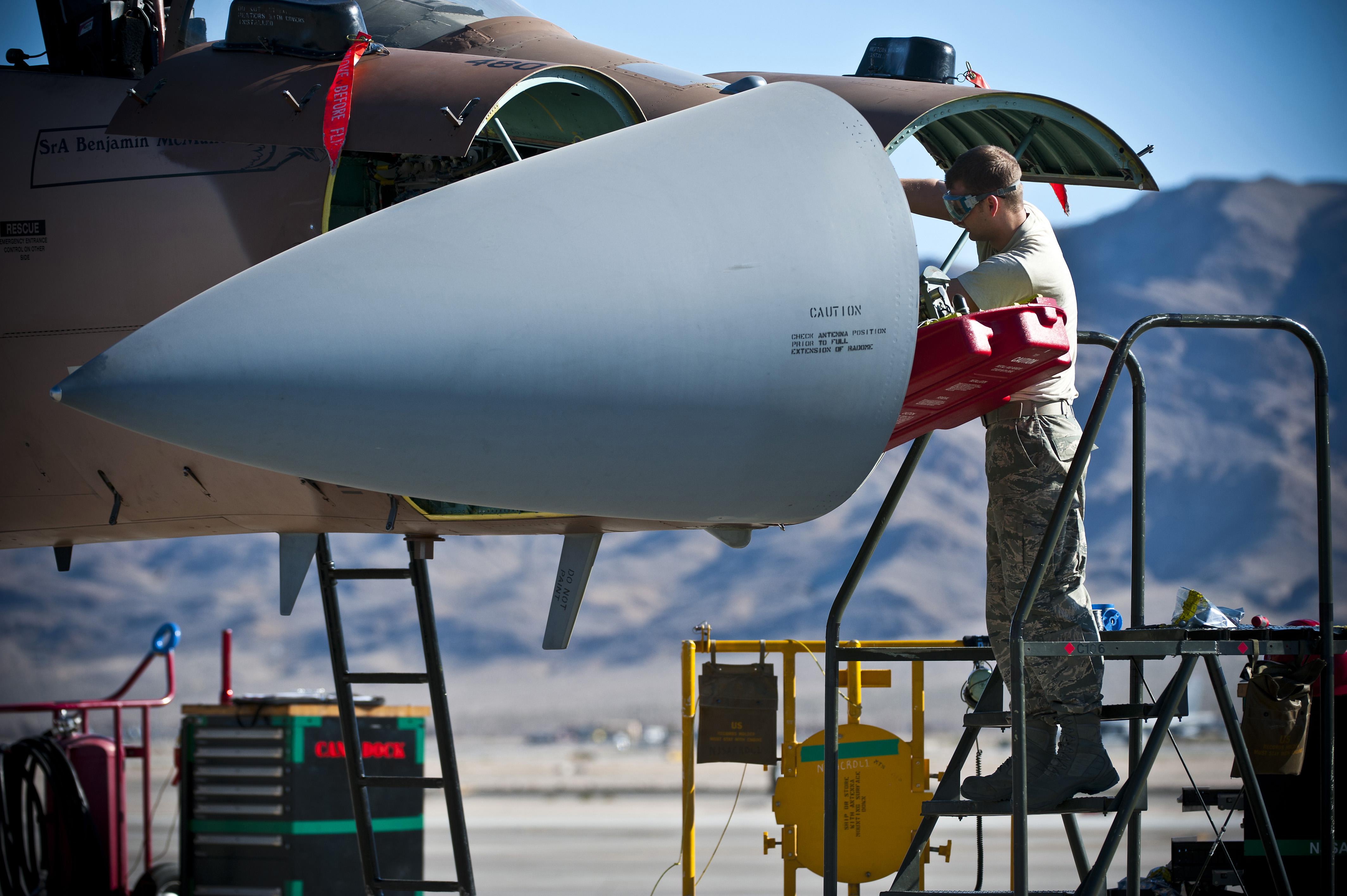 Air Force Senior Airman Brion Humenay works on the nose of an F-15 ...
