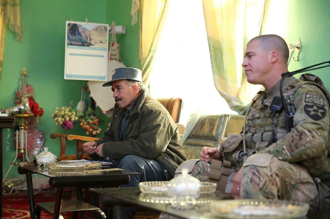 Abdul Qayoom, Farah City prison commander, left, listens to the ...