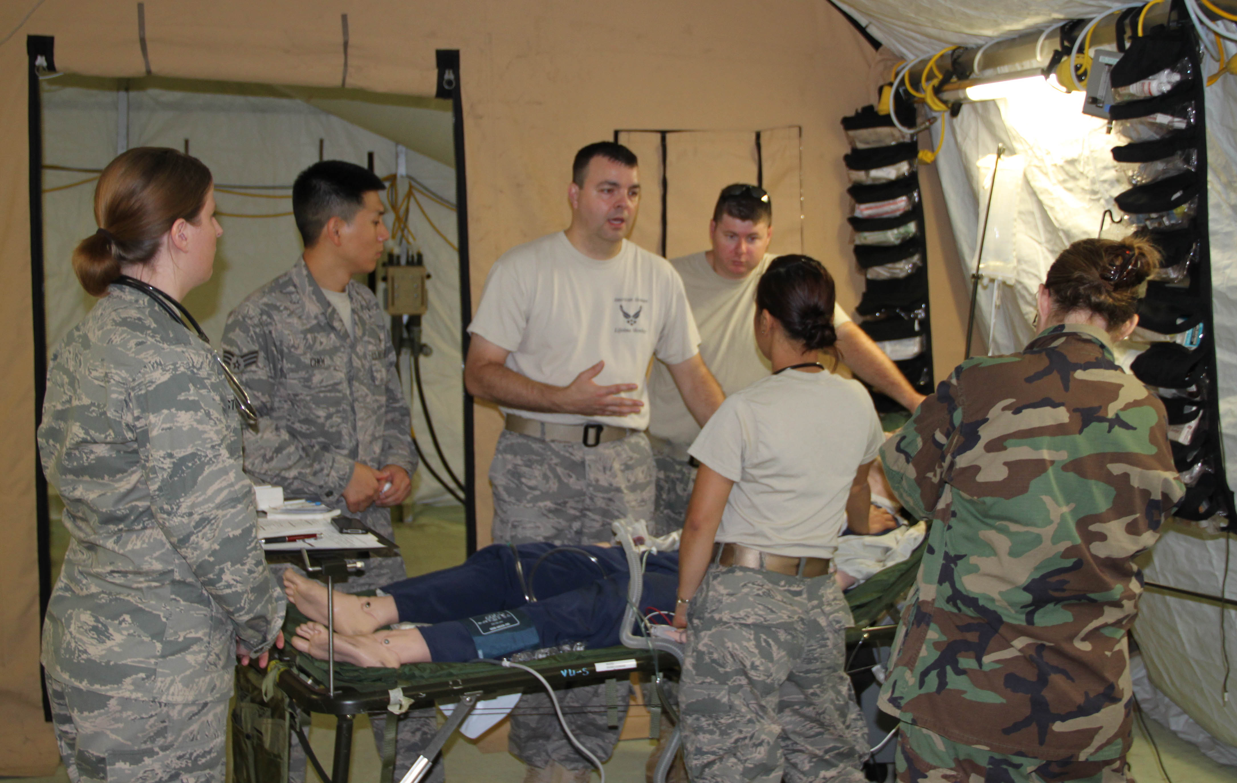 Air Force Maj. David Whitehorn, center, a critical care trauma nurse ...