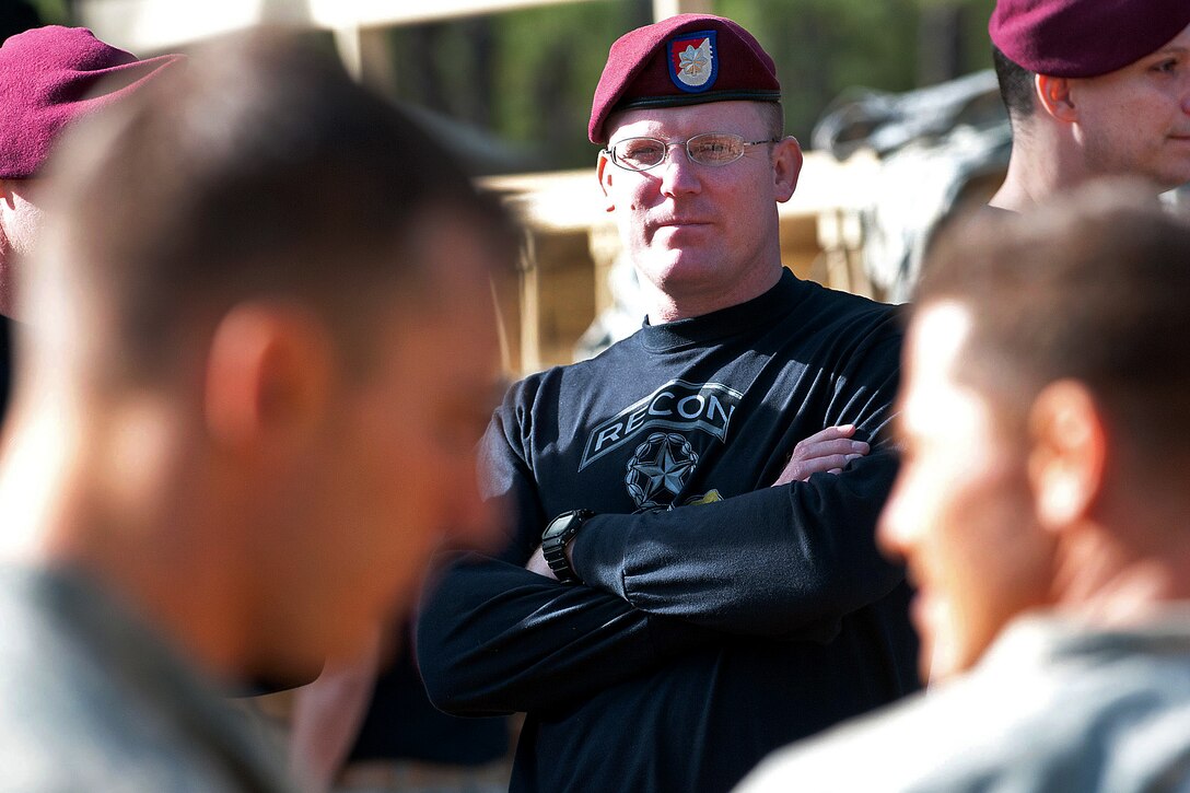 Army Lt. Col. Mark Dotson, center, oversees a team event wherein ...