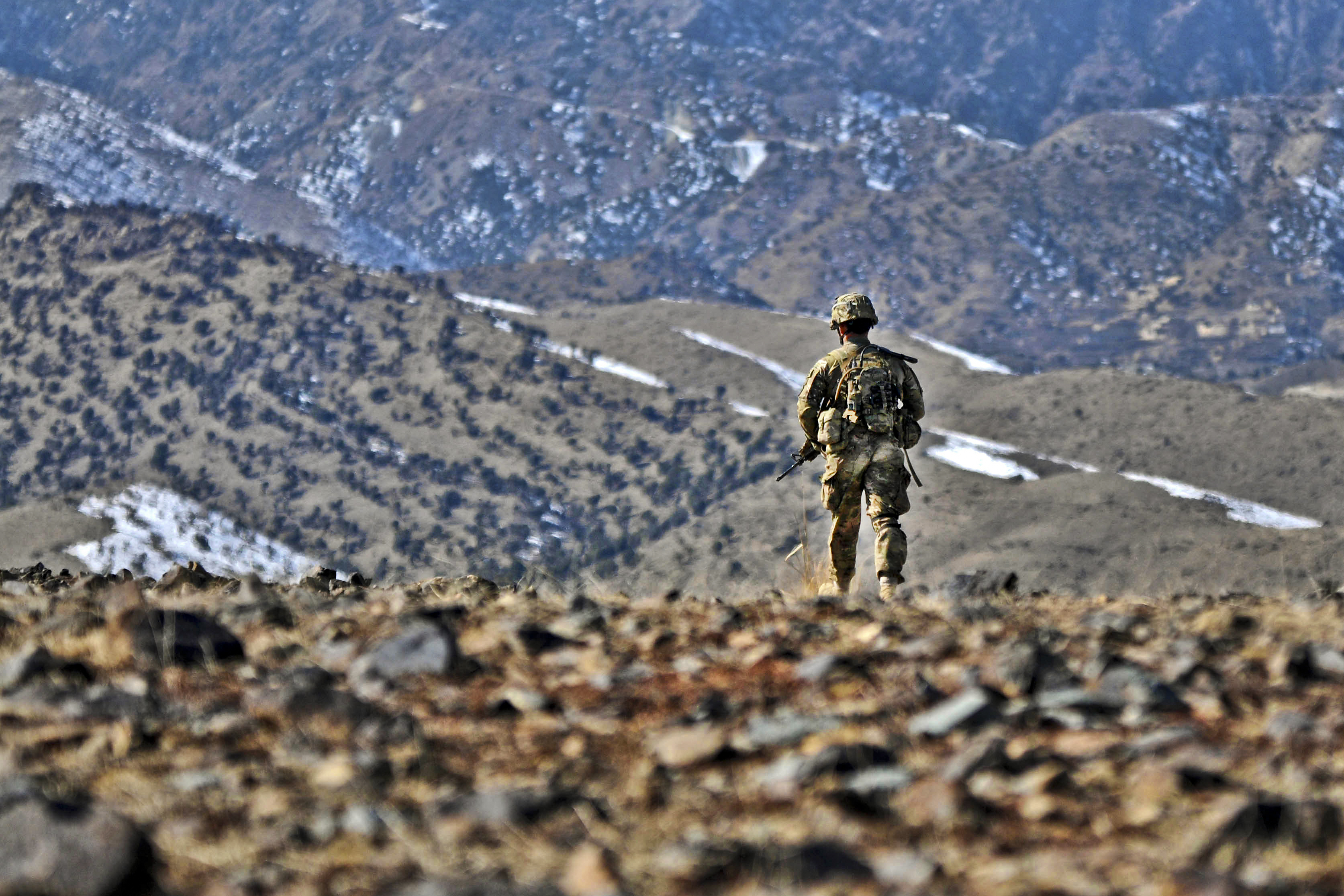 U.S. Army Sgt. Ryan Gerber prepares to descend into a valley near the ...