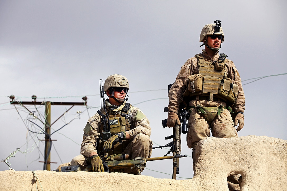A U.S. Marine Corps sniper team prepares to provide cover during ...