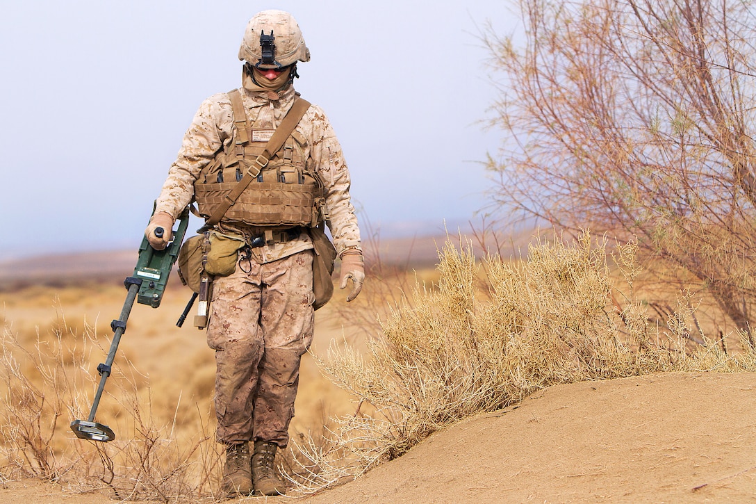 U.S. Marine Corps Lance Cpl. Matthew Bayles sweeps for weapons and drug ...