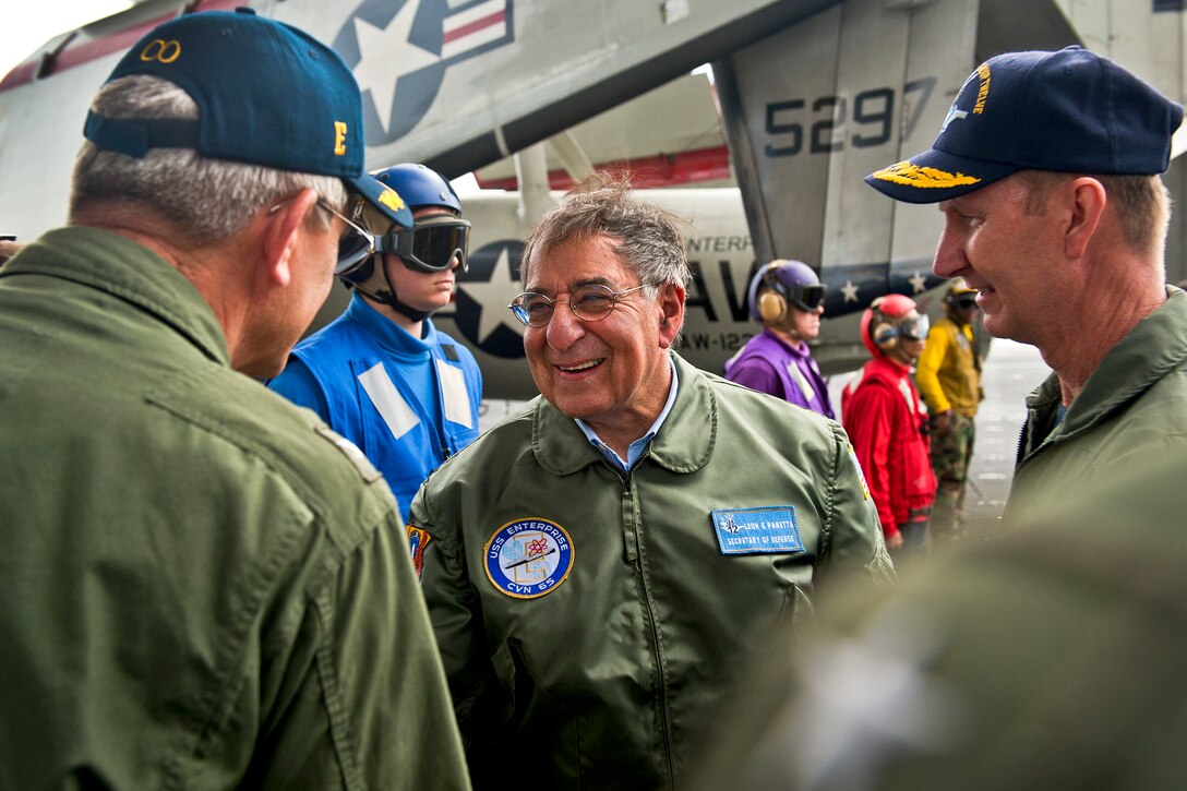 Defense Secretary Leon E. Panetta talks with Navy Capt. William C ...