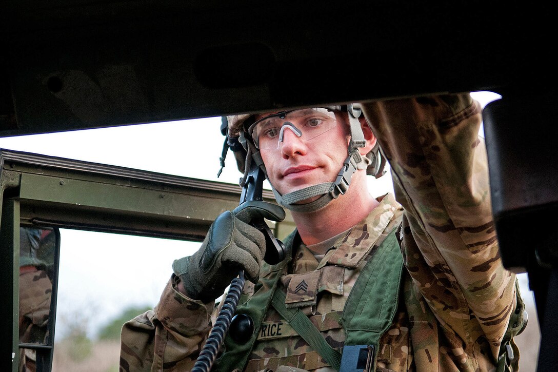 Army Sgt. Adam Rice establishes radio communication with the other ...