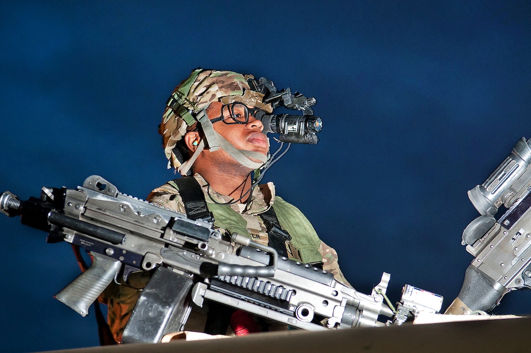 Army Pvt. Rodrell Green mans an M240 B machine gun atop a Humvee during ...