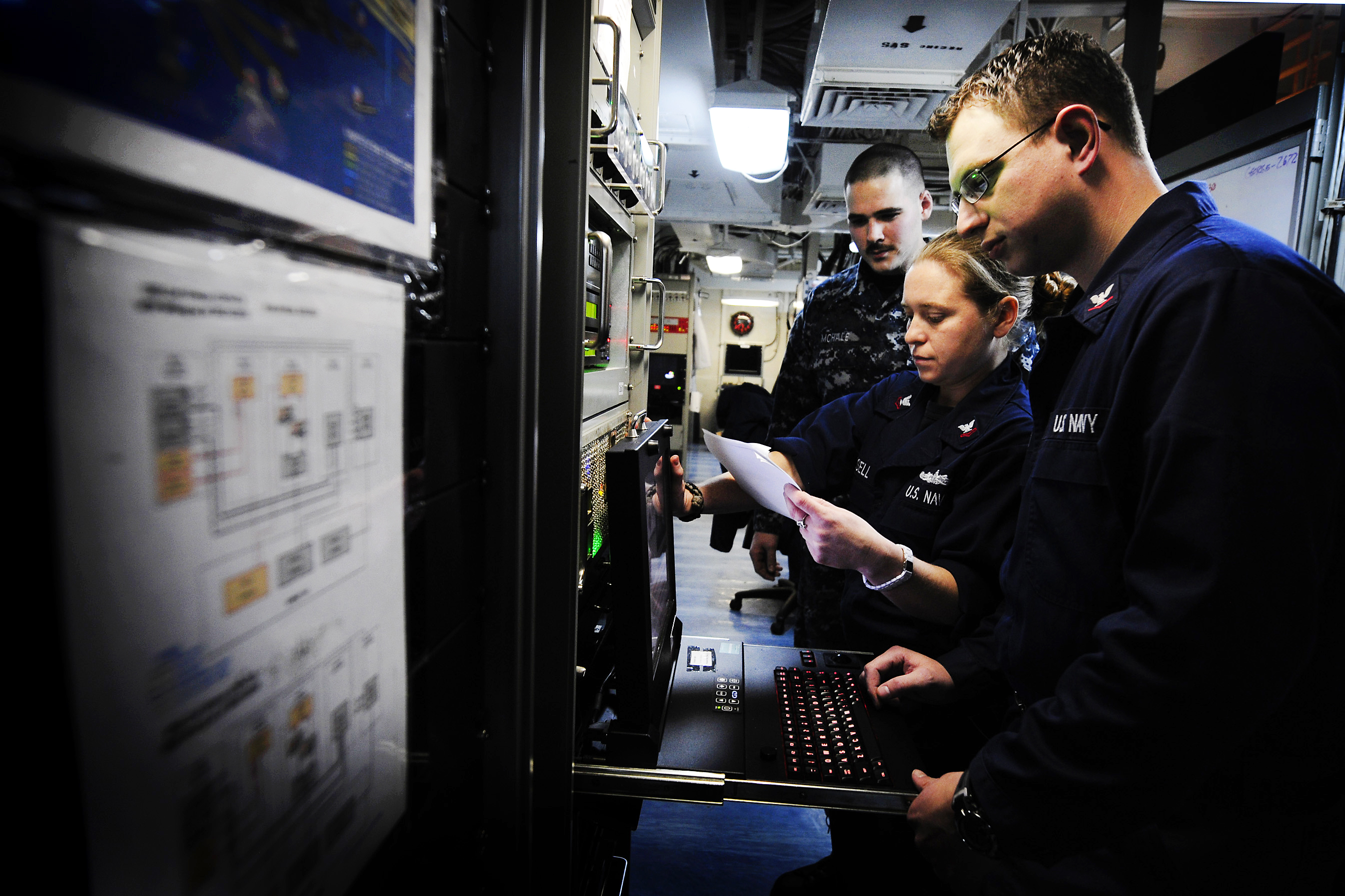 U.S. Navy Seaman Patrick McHale, left, Petty Officers 2nd Class Sheri ...
