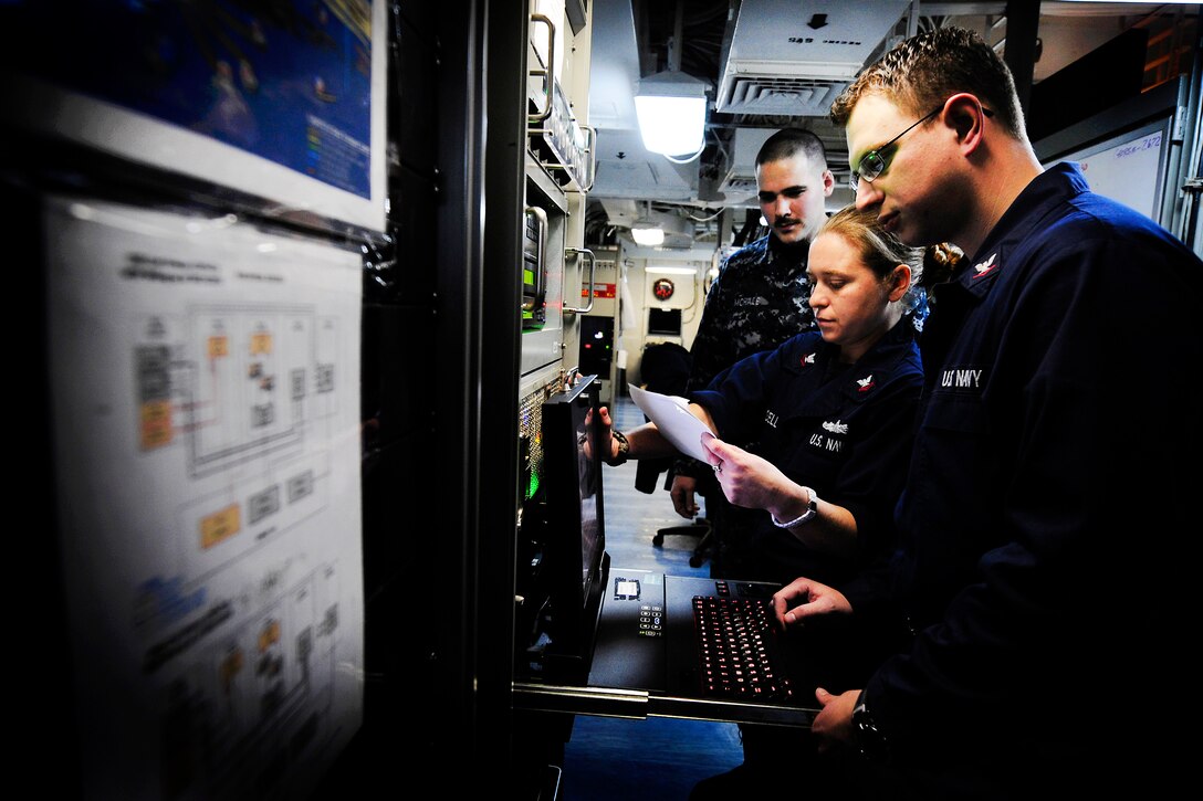 U.S. Navy Seaman Patrick McHale, left, Petty Officers 2nd Class Sheri ...