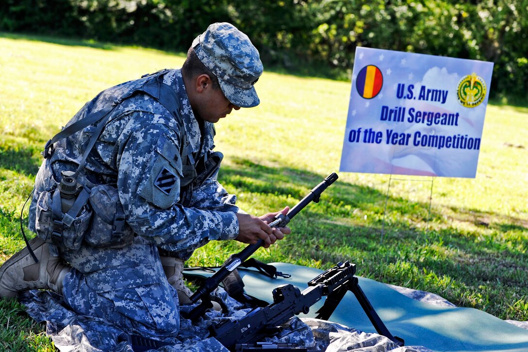Army Staff Sgt. Victor Marquez-Rodriguez Sr. puts together a M240B ...