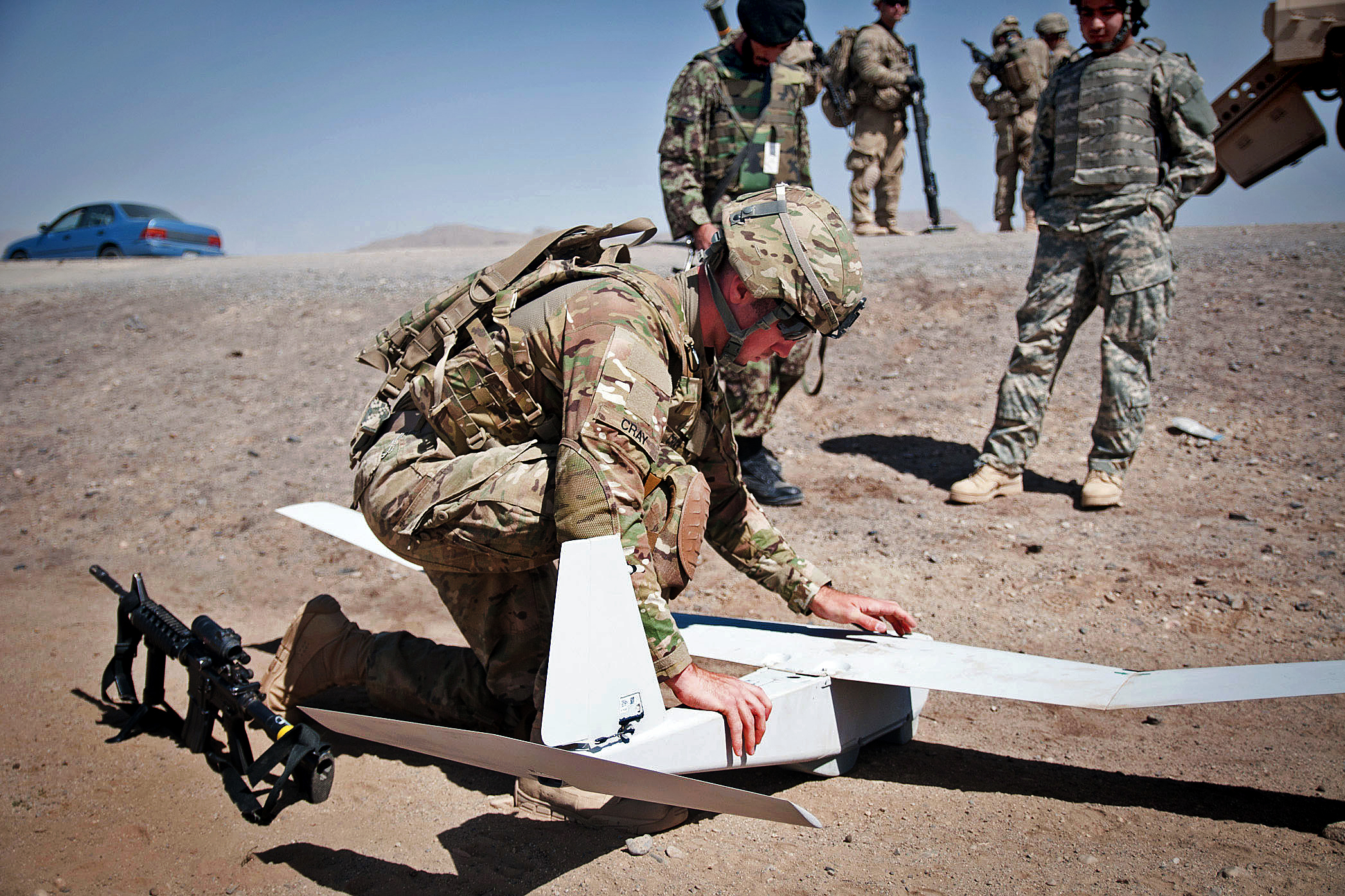 U.S. Army Spc. Eric Cray attaches the wings of a Puma unmanned aerial ...