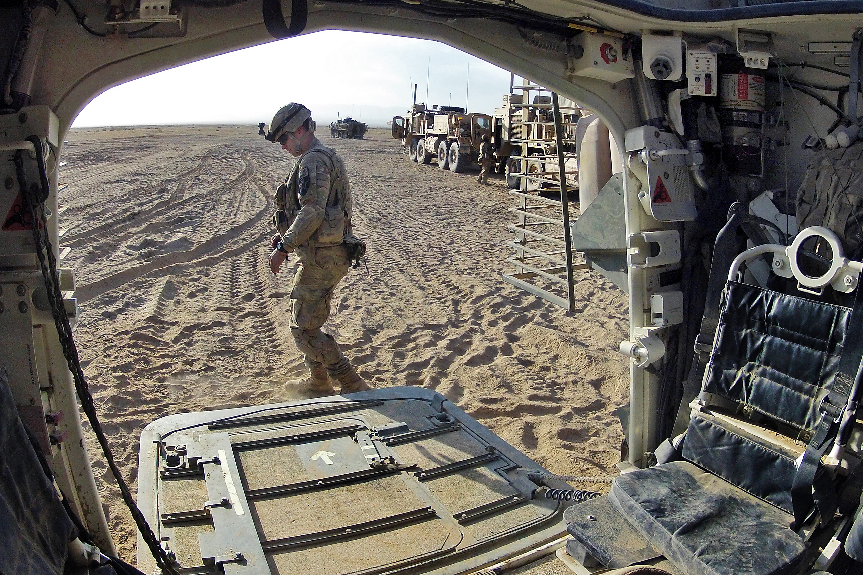 U.S. Army Spc. Jesse Border walks outside his Stryker vehicle during ...