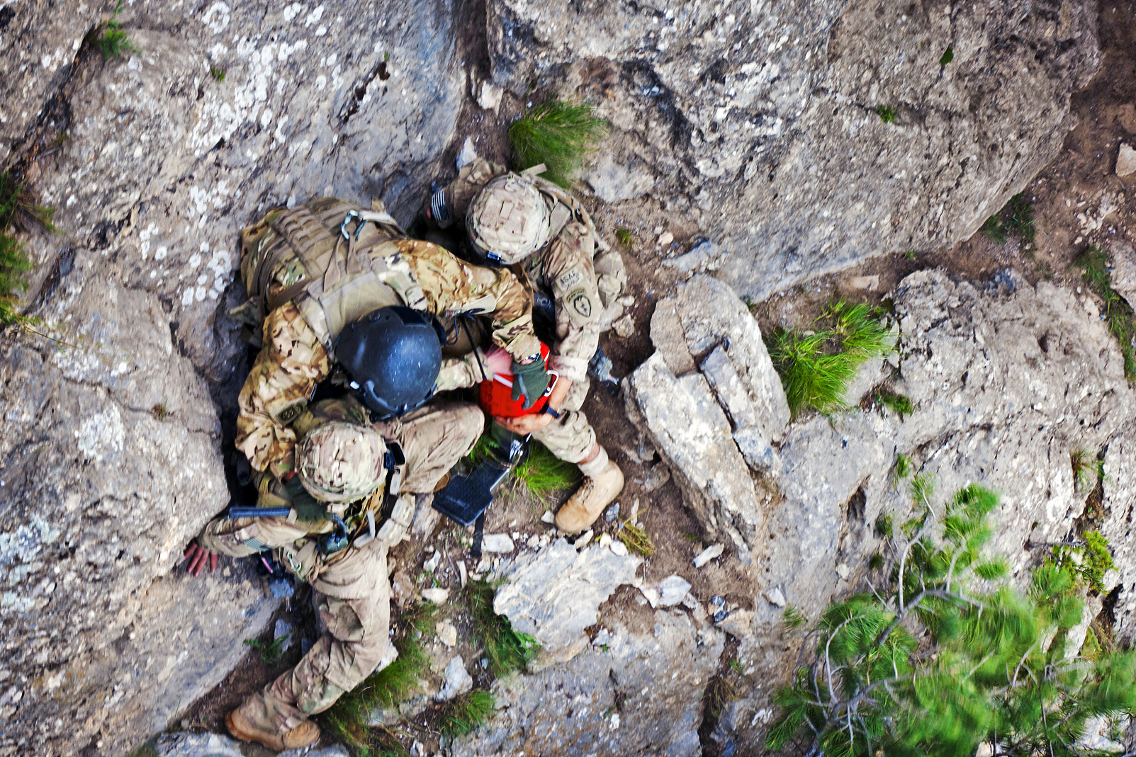 U.S. Army Staff Sgt. Patrick Rogers, center, helps U.S. Army Pfc ...
