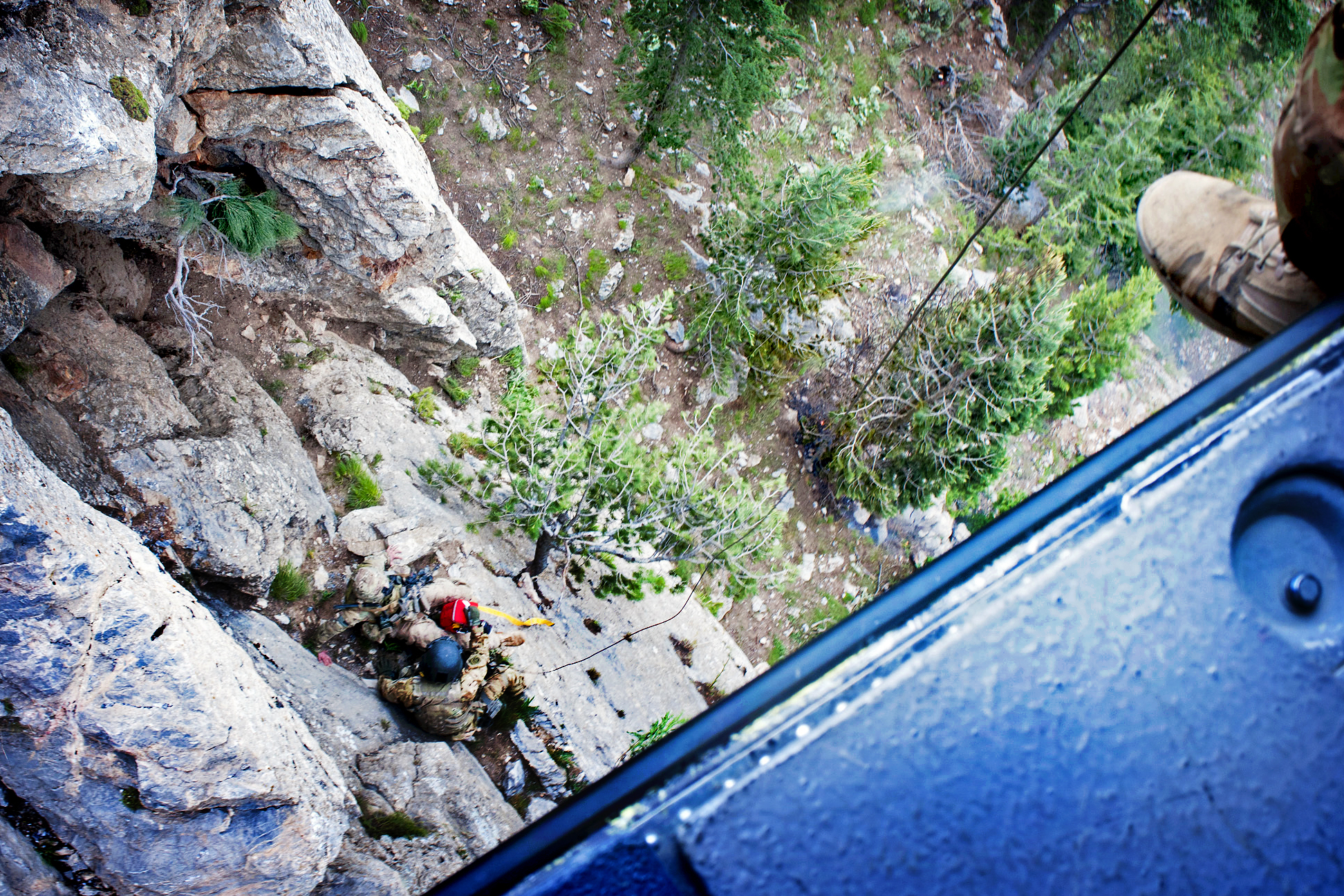 U.S. Army Staff Sgt. Patrick Rogers, right, helps secure Army Staff Sgt ...