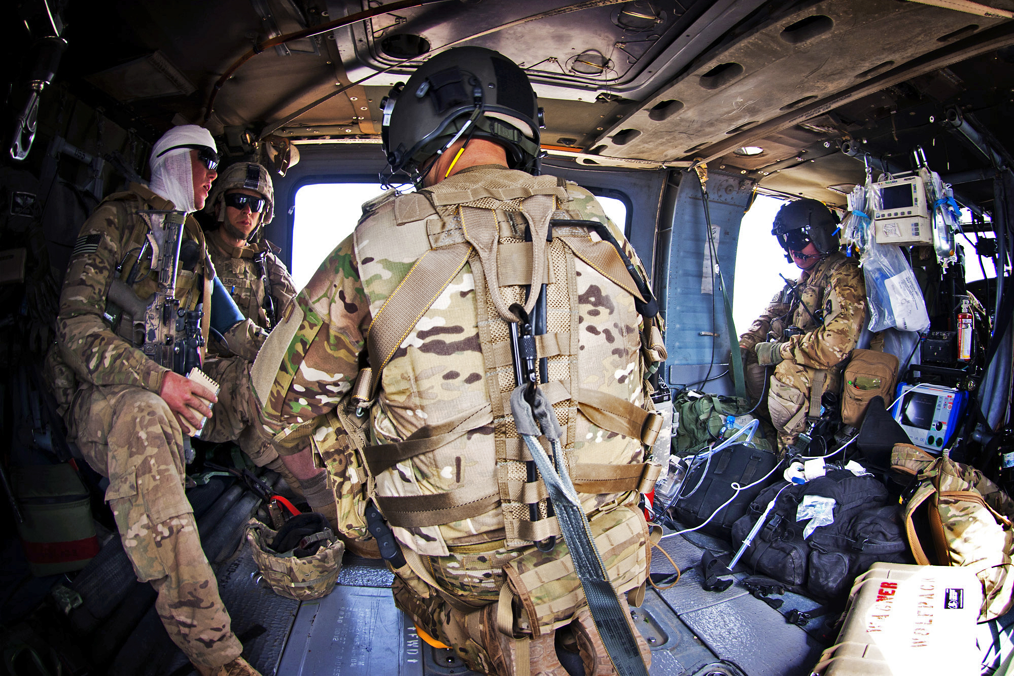 U.S. Air Force Lt. Col. Brett Wood, front, treats U.S. Army Staff Sgt ...