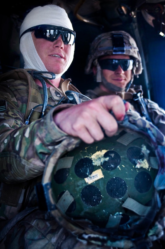 U.S. Army Pfc. Michael Halberg, right, looks on as U.S. Army Staff Sgt ...