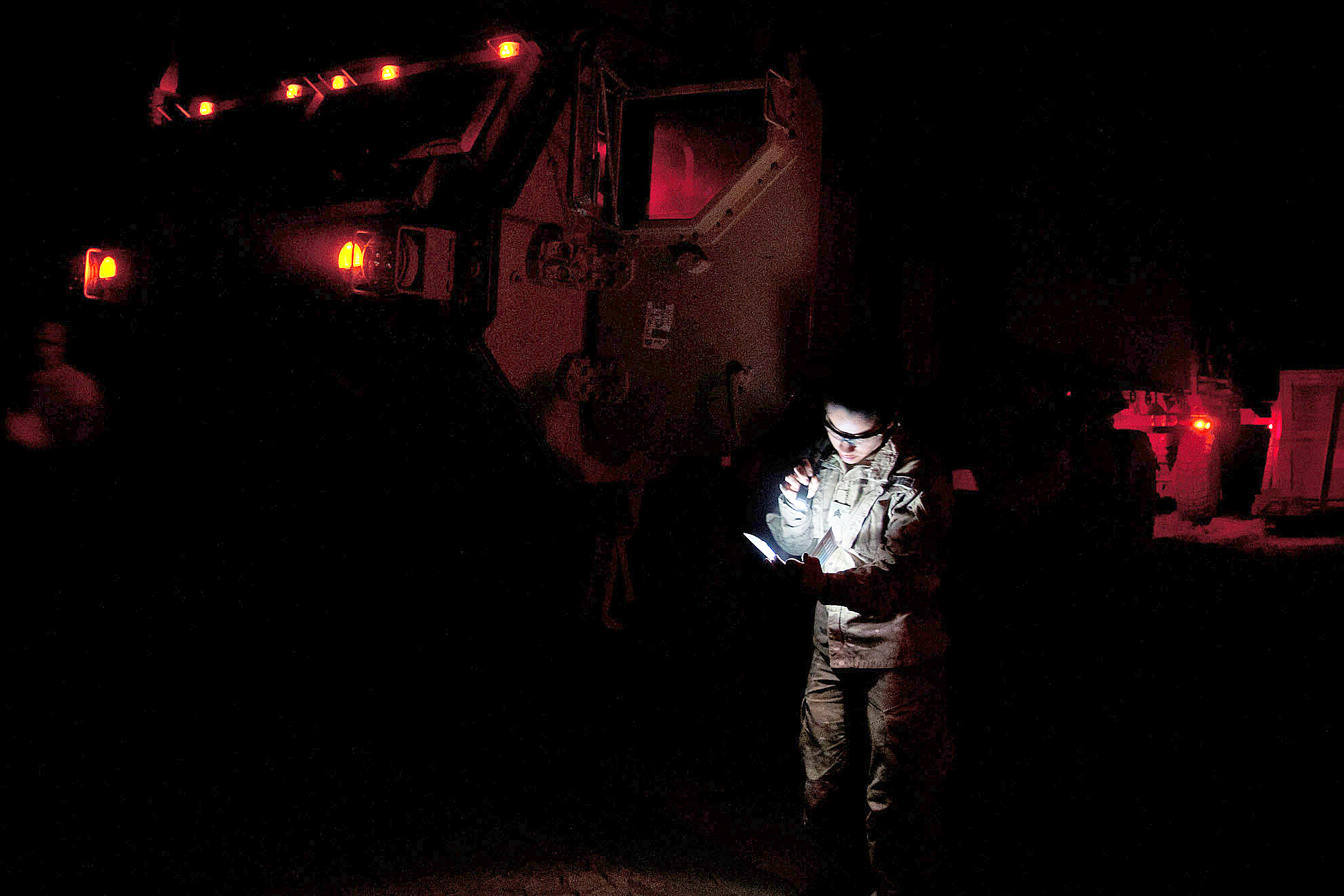 U.S. Army Sgt. Nancy Hernandez checks her notes while organizing ...