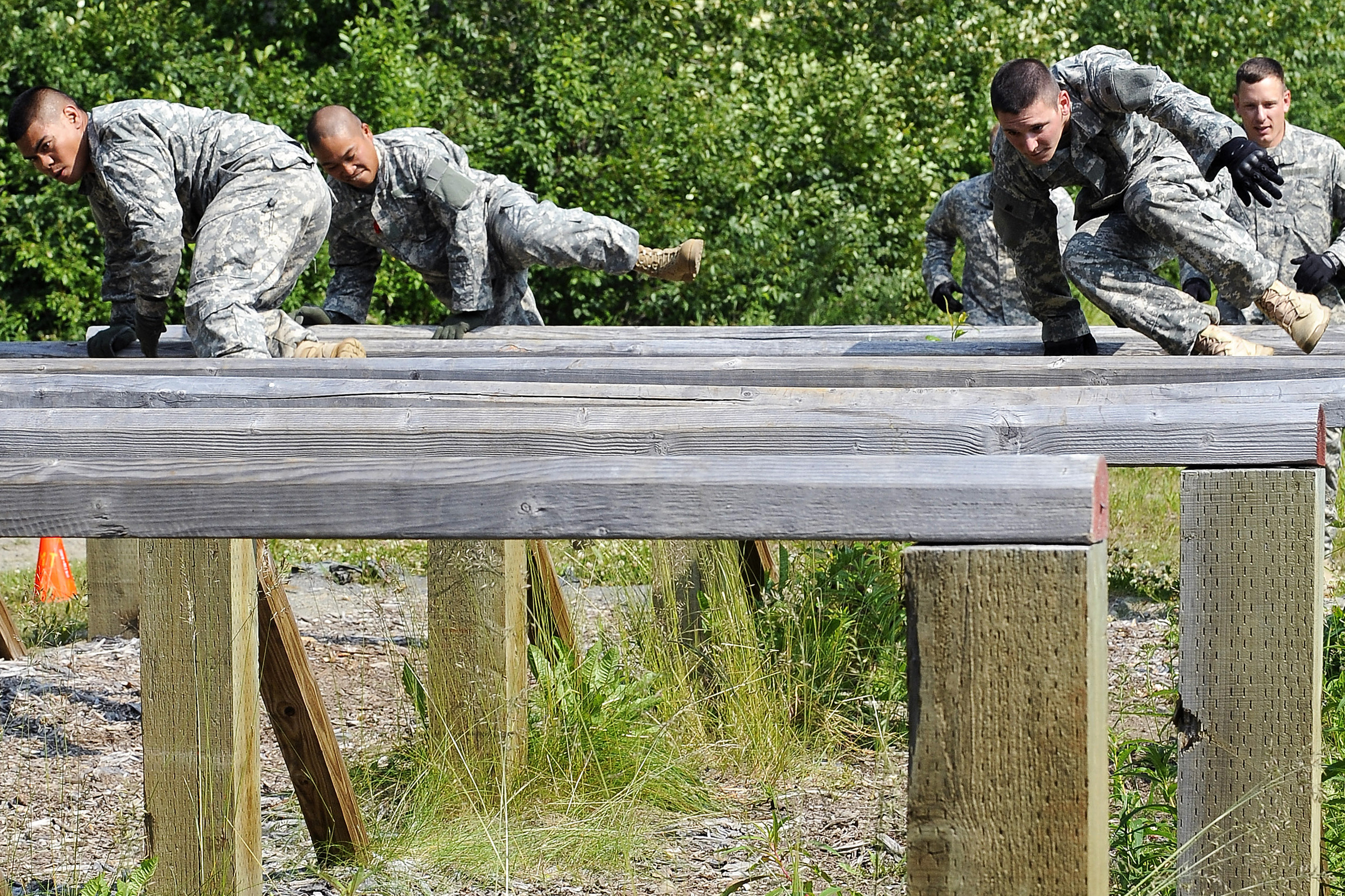 Soldiers tackle the hurdle obstacle during joint operations training ...