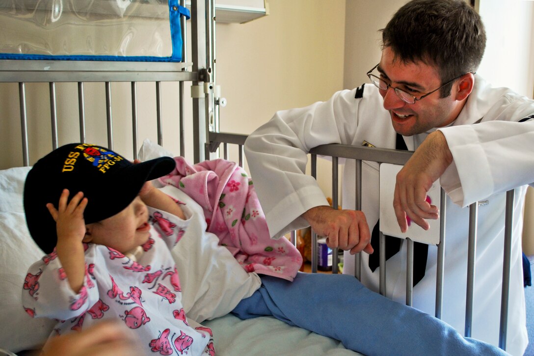 Navy Petty Officer 1st Class Robert Richardson gives a patient at the ...