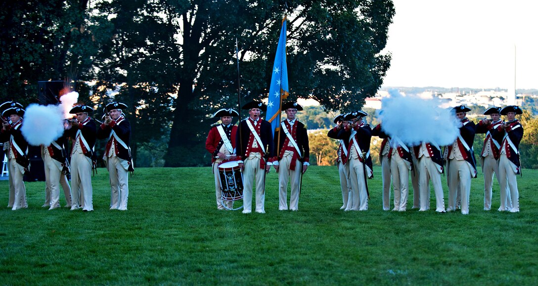 Army soldiers fire their muskets during Twilight Tattoo at Whipple ...