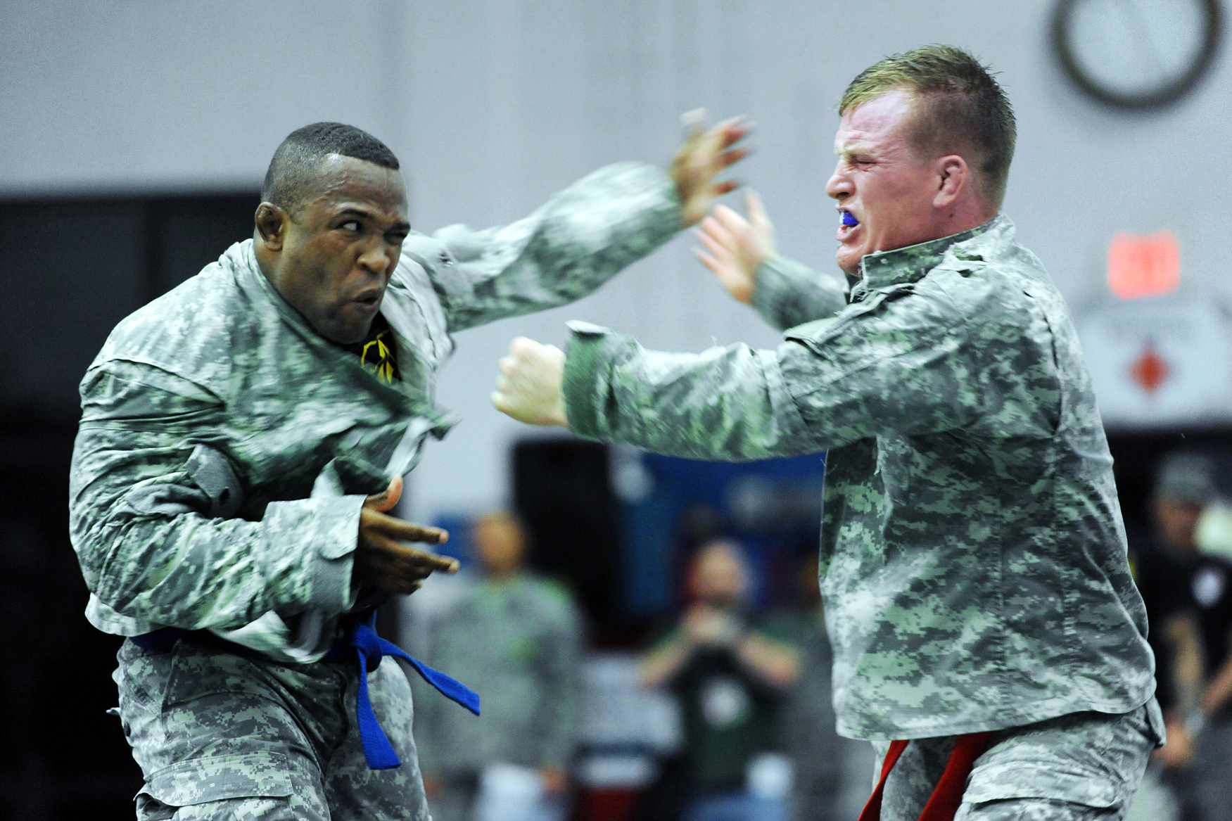 Army 1st Lt. Daniel Midgett, right, exchanges open-handed blows with ...