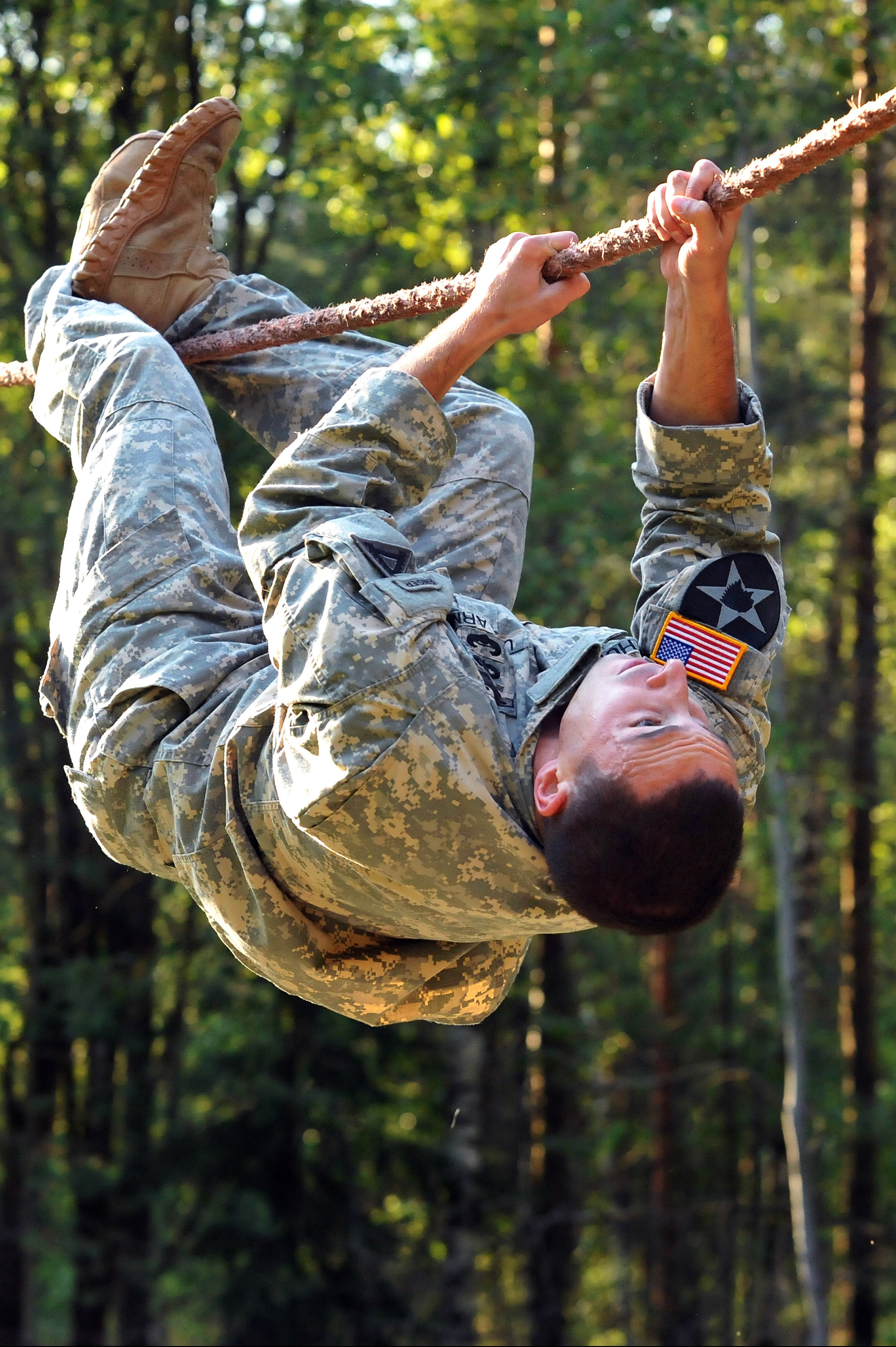 U.S. Army Capt. John Arthur navigates through an obstacle course during ...