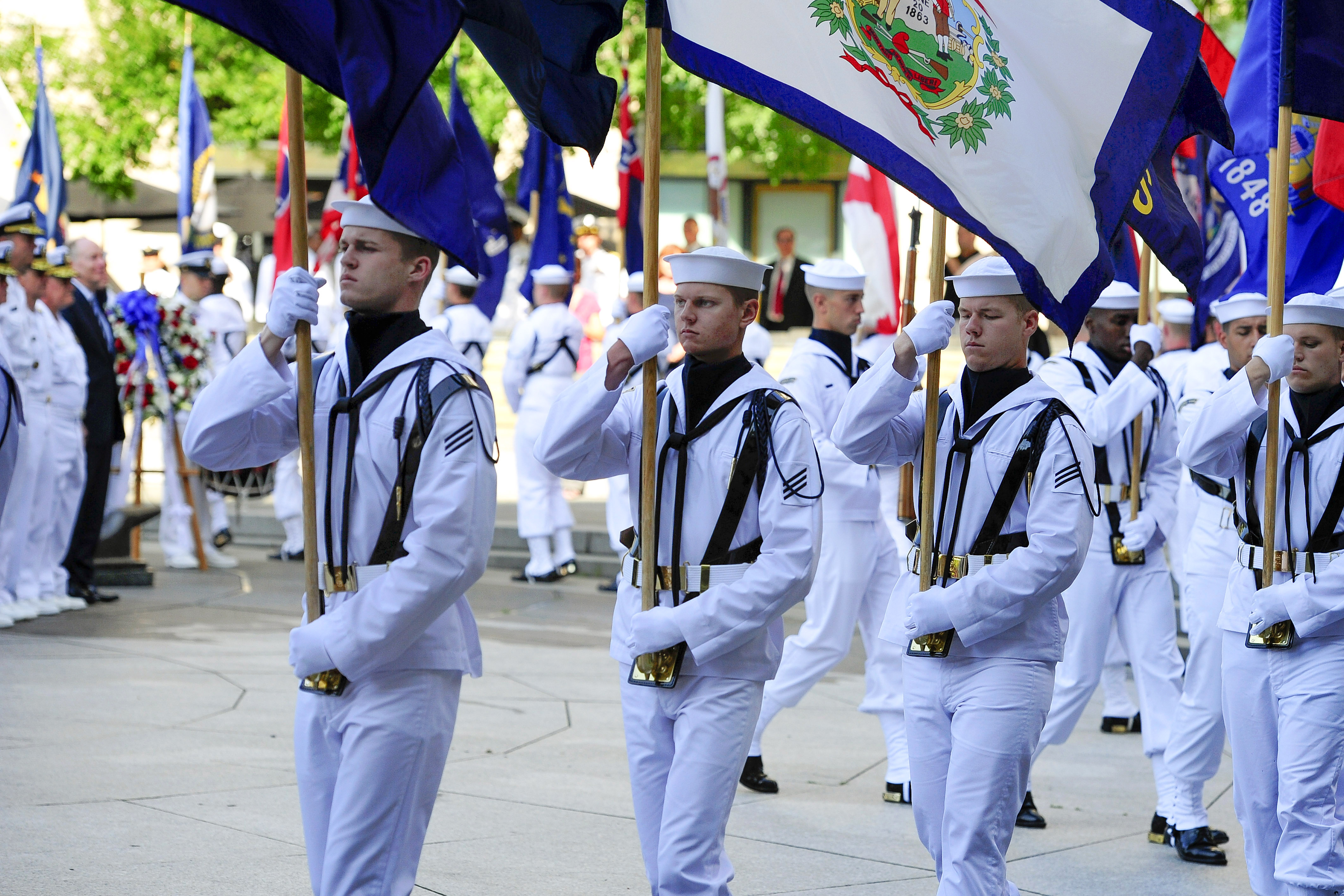 Members of the Navy Ceremonial Guard parade the fifty state flags ...