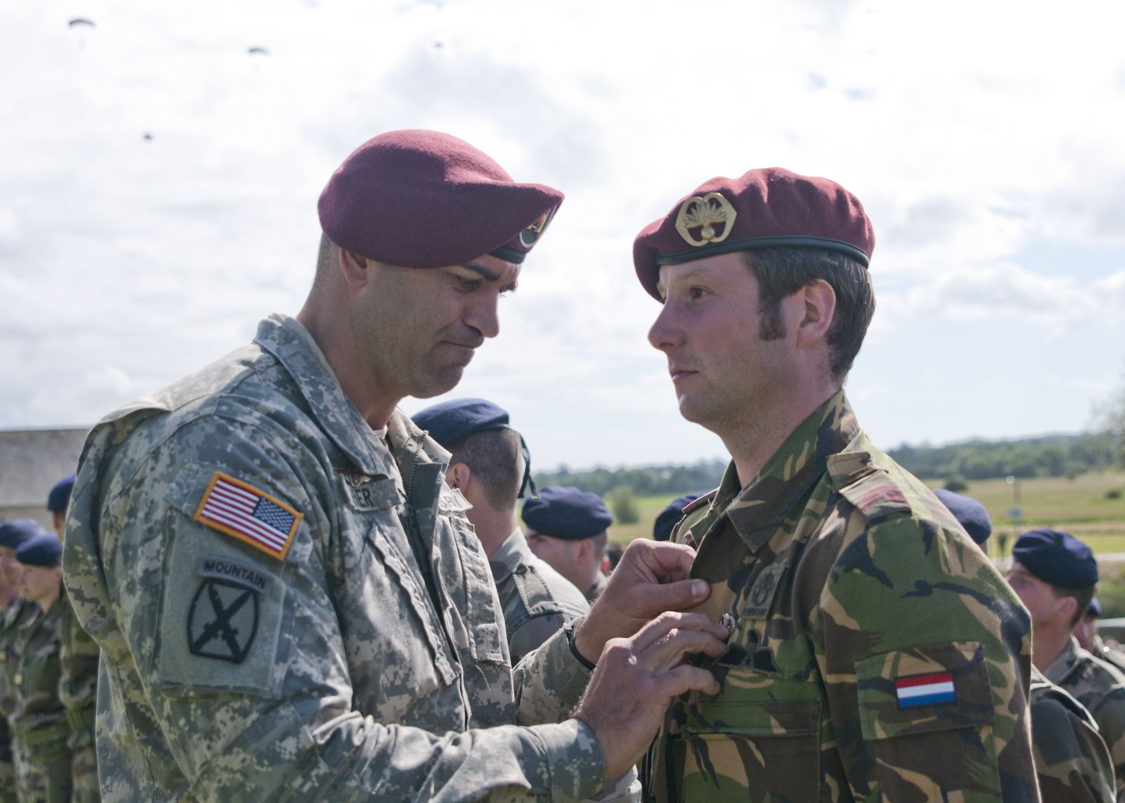 U.S. Army Capt. Brett Baker pins on U.S. jump wings onto allied forces ...