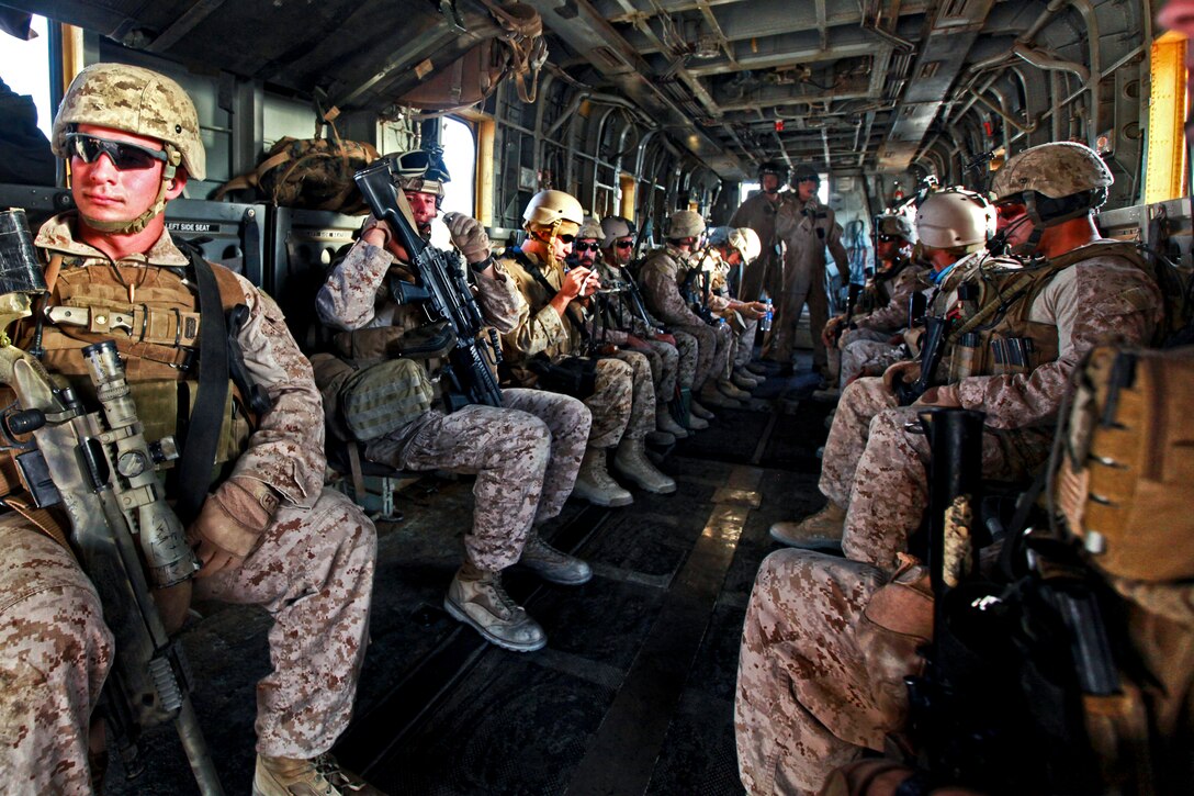 U.S. Marines and members of the Afghan National Interdiction Unit, a ...