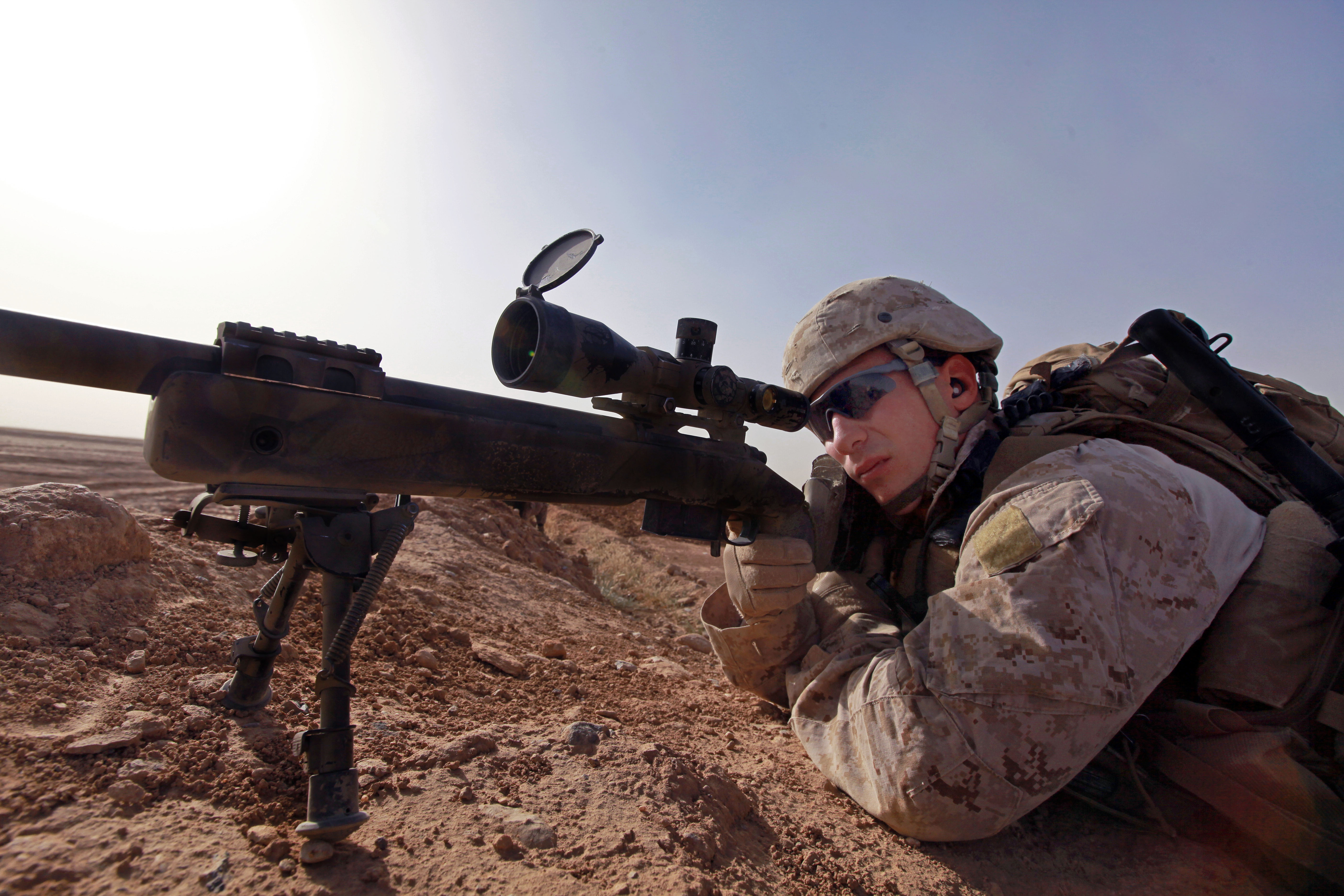 U.S. Marine Corps Sgt. Brian Matthews looks through his weapon's scope ...