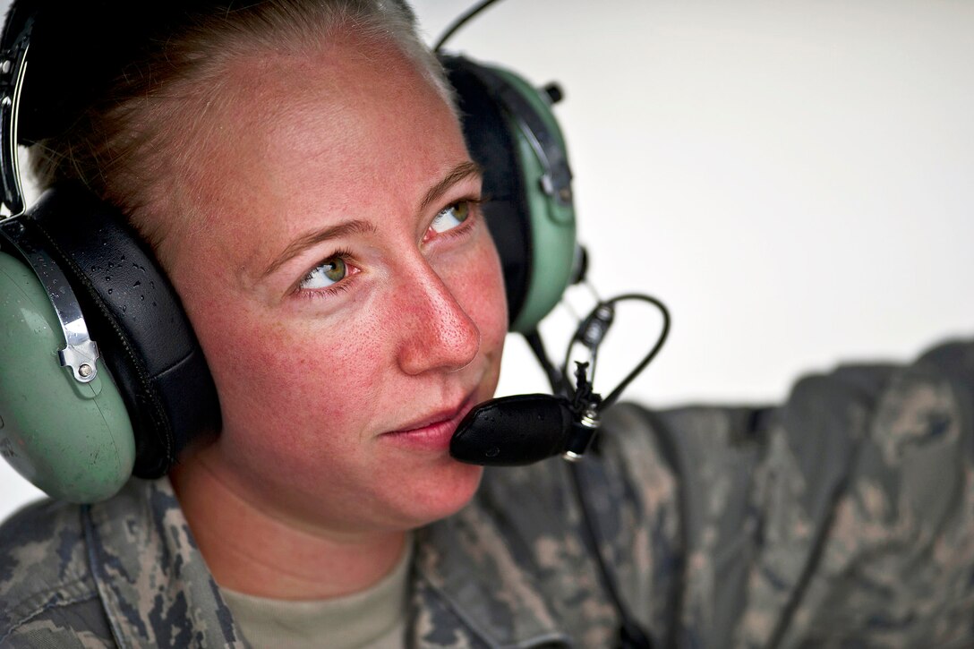 U.S. Air Force Airman 1st Class Sarah Sagers speaks with a pilot before ...