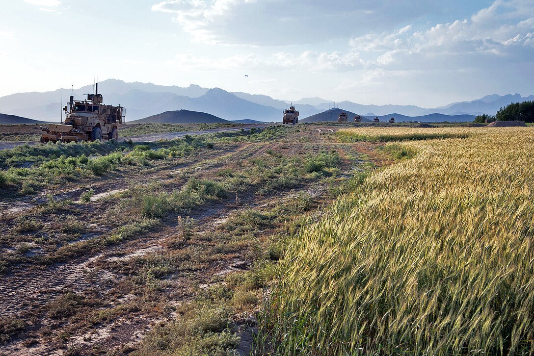 U.S. soldiers drive a convoy of U.S. Army vehicles to Joint Security ...