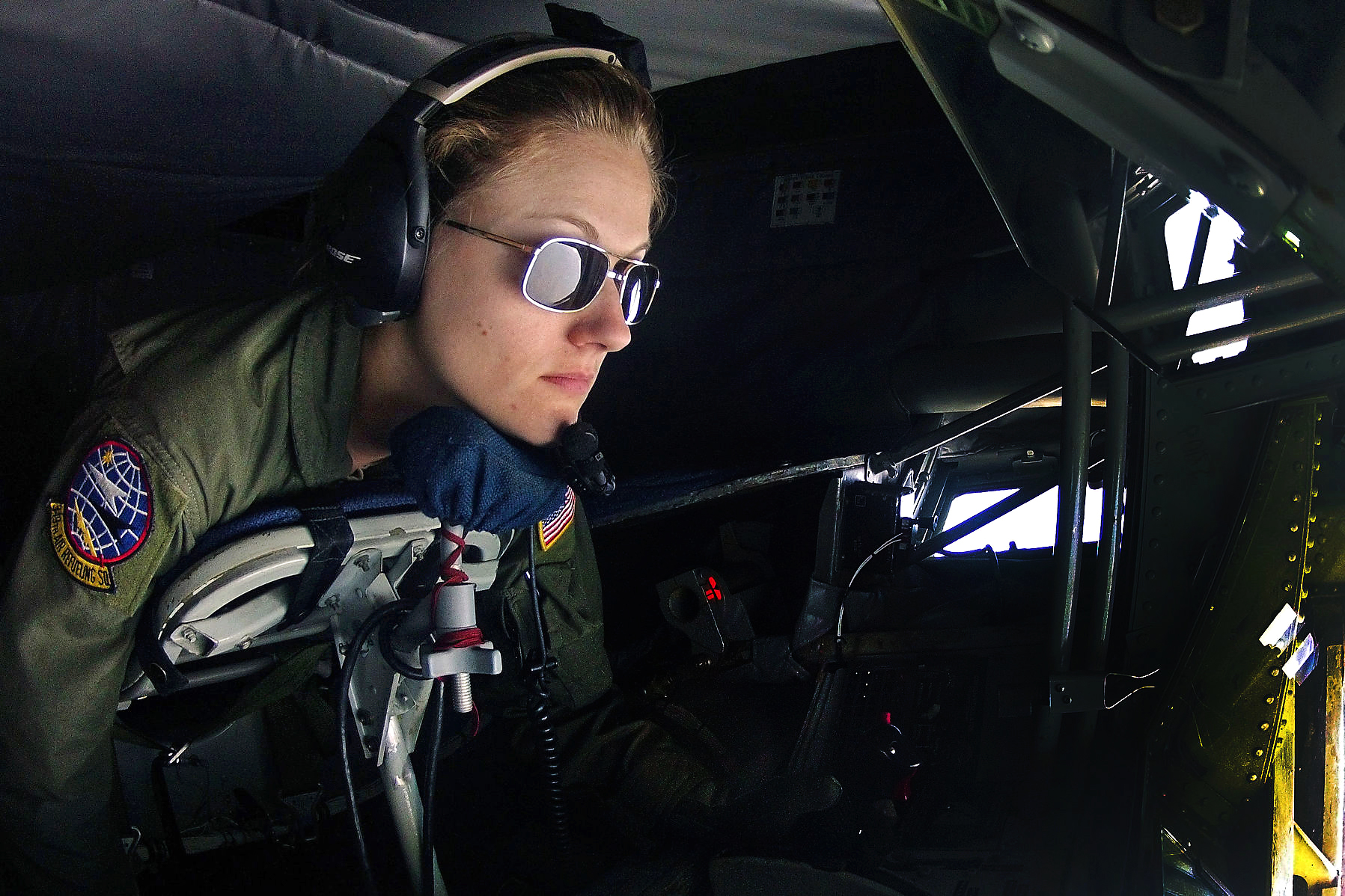 U.S. Air Force Senior Airman Catherine Norcom looks out from a U.S. Air ...