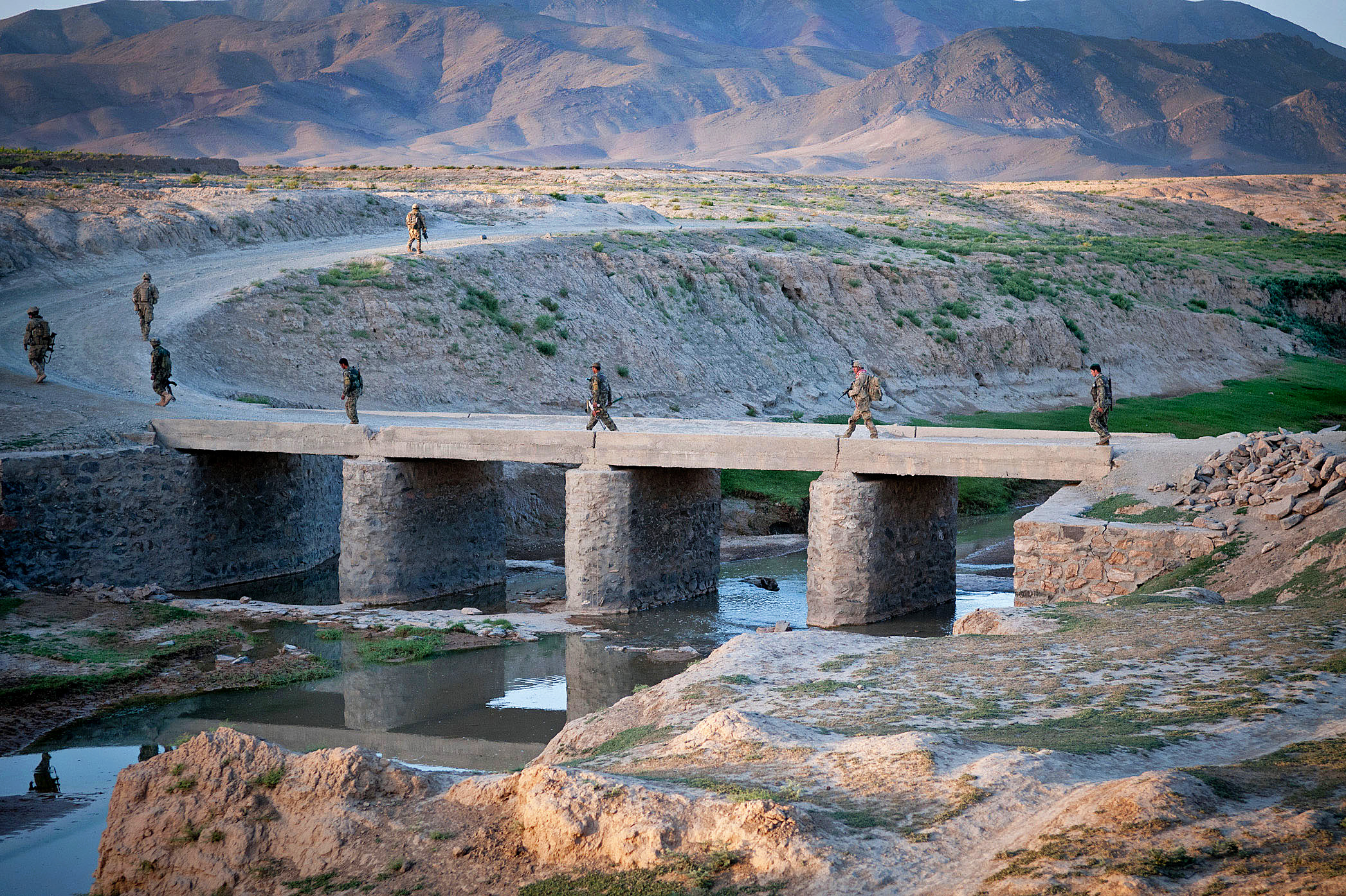 U.S. paratroopers and Afghan soldiers patrol across the Tarnak River in ...