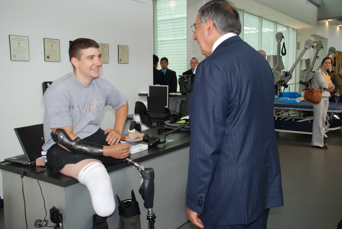 Army Capt. Larkin O'Hern shares a laugh with Defense Secretary Leon E ...