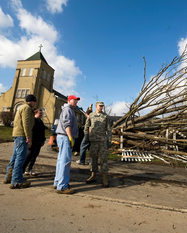 Army Pfc. Andrew Palmer speaks with residents of Henryville, Ind ...