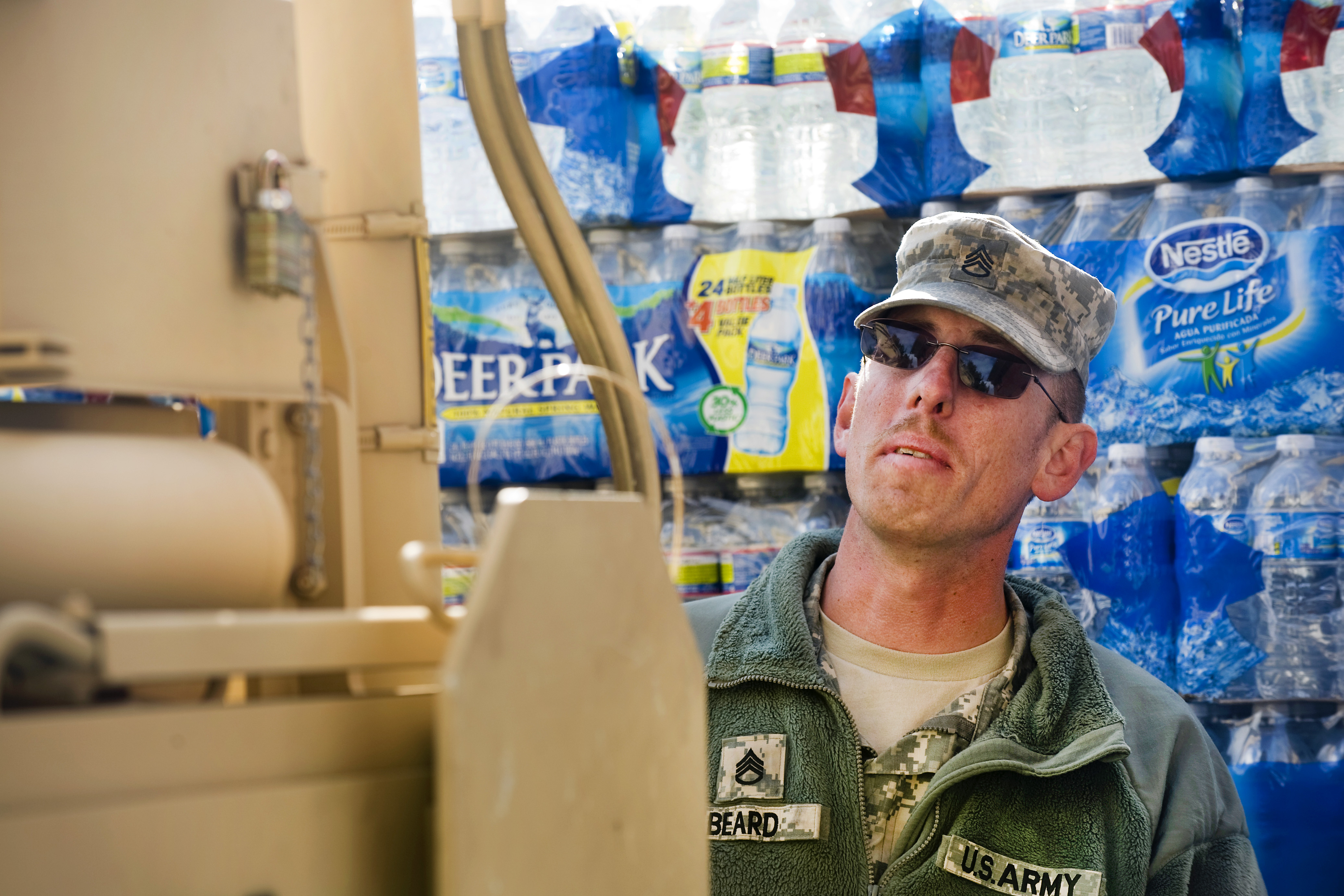 Army Staff Sgt. Gregory Beard delivers bottled water to residents of ...