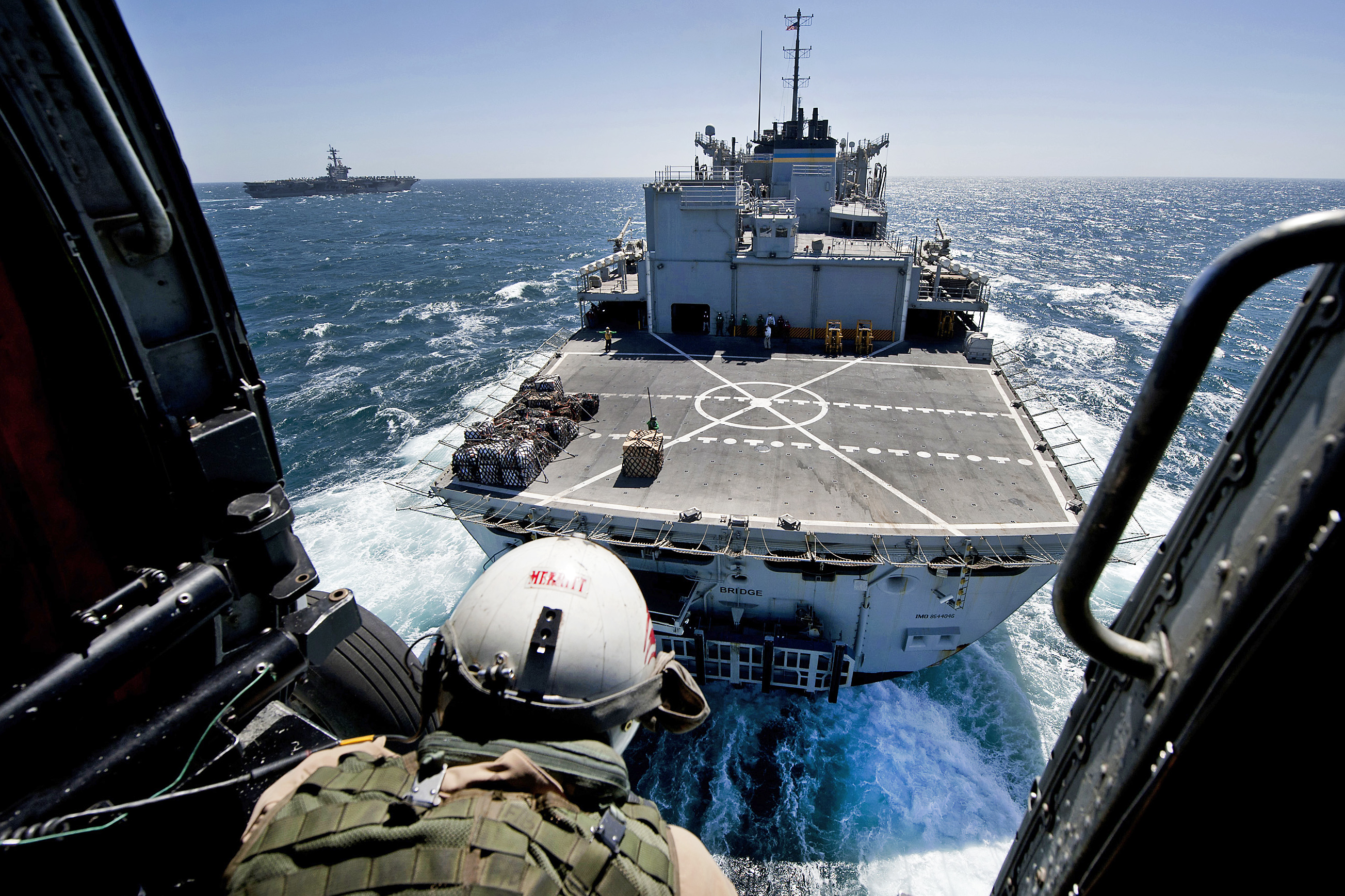 U.S. Navy Petty Officer 2nd Class Cory Merritt guides the pilots of an ...